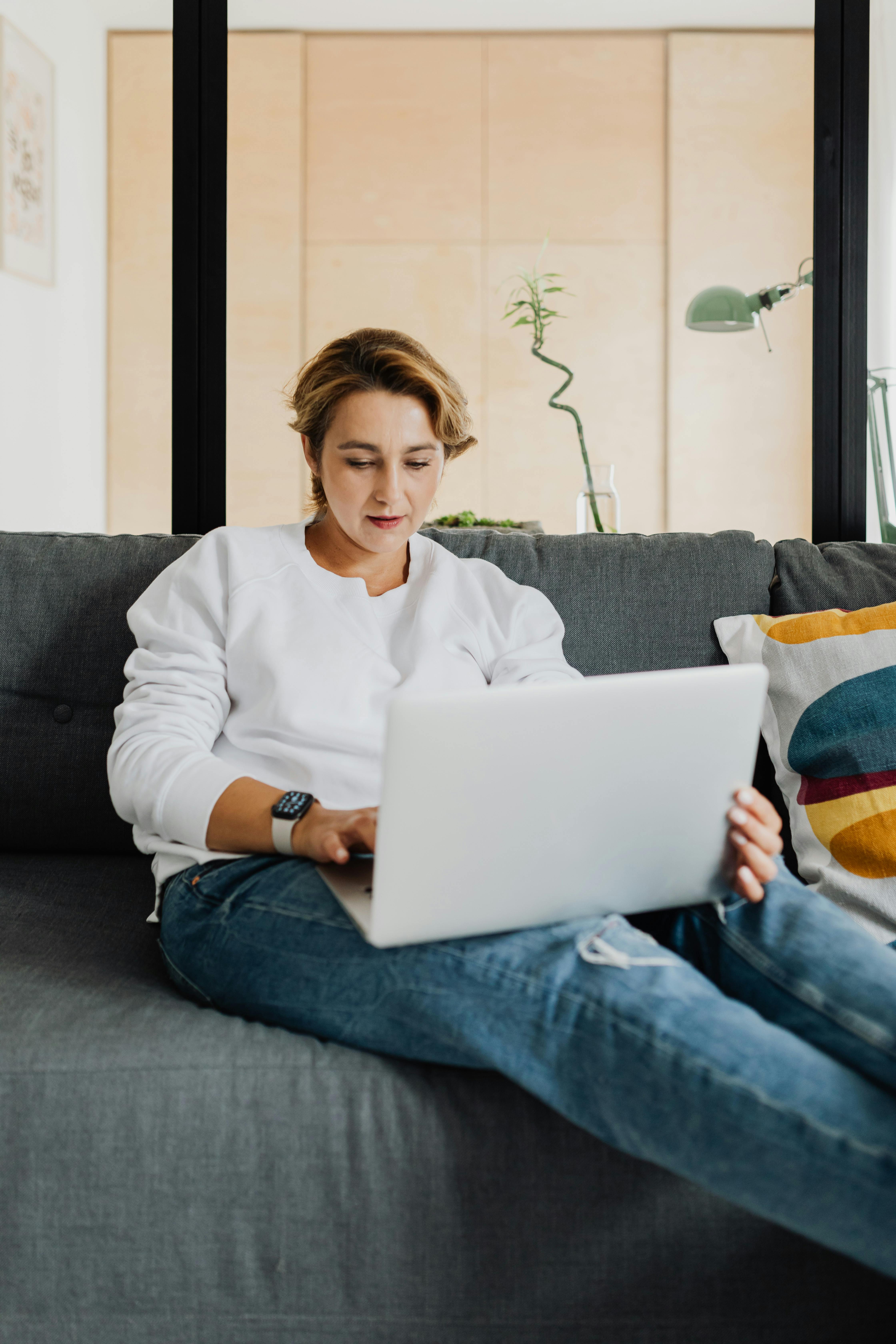 Young Asian female freelancer using gadgets while working at home ...