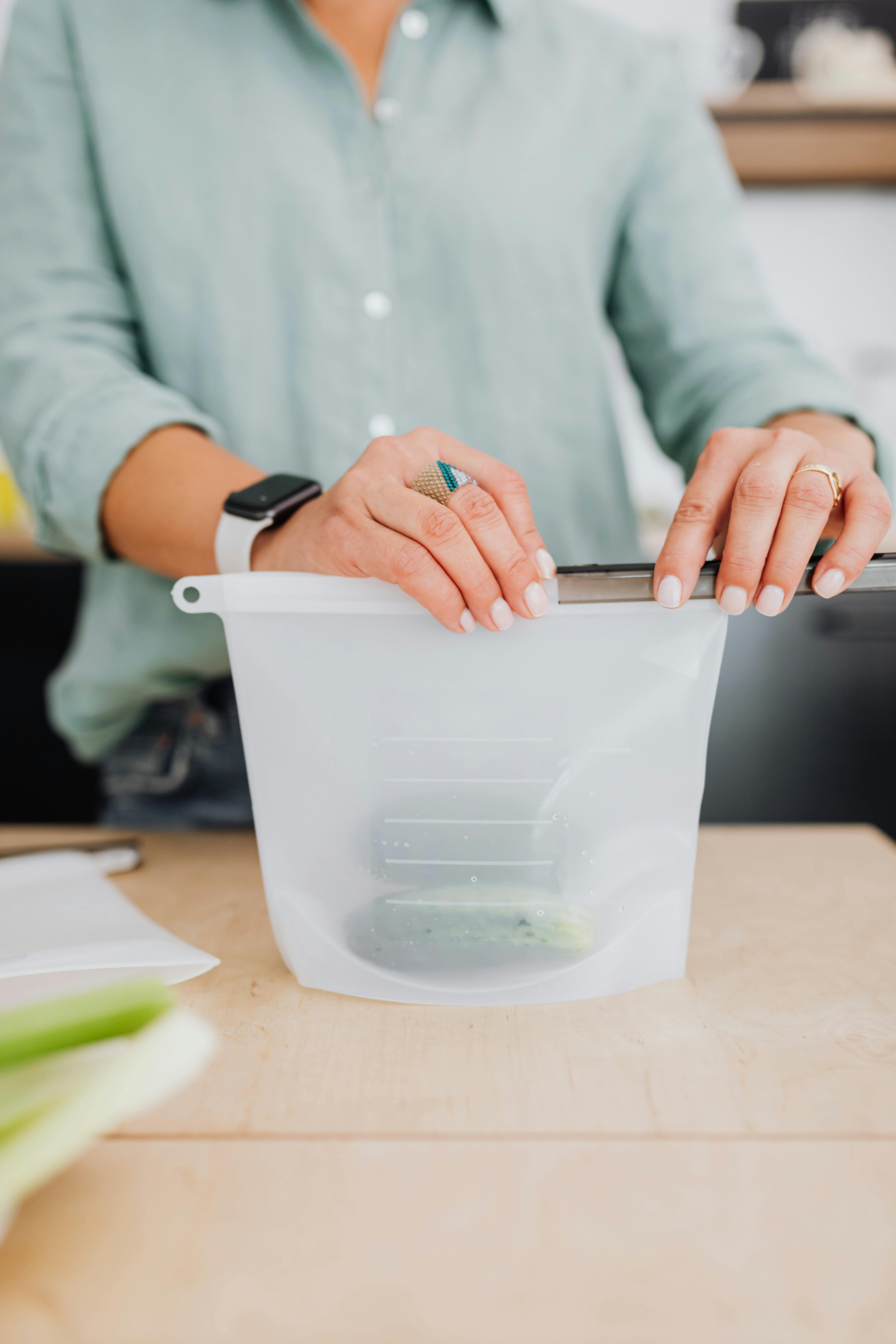 Woman Closing a Plastic Container · Free Stock Photo