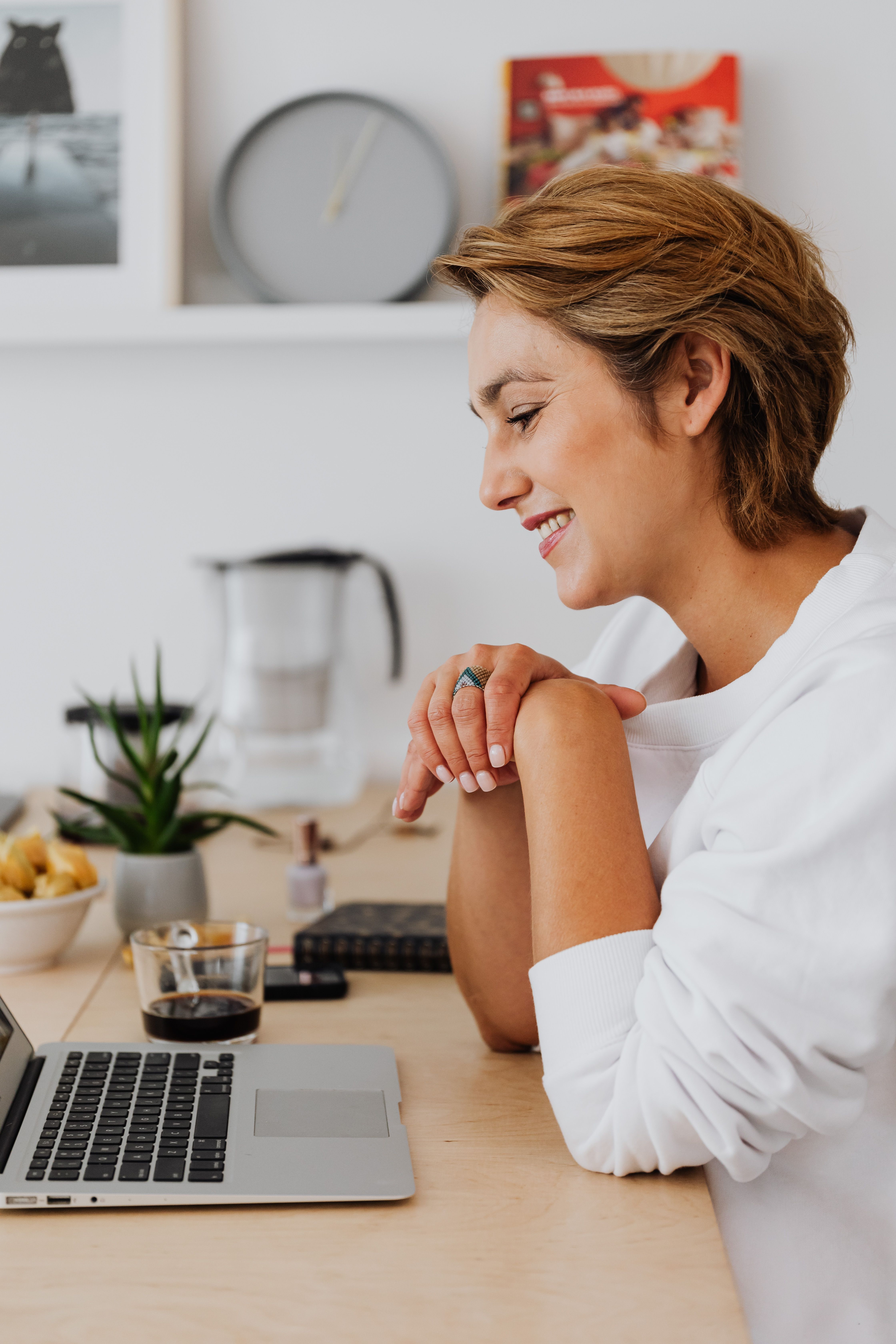 Young Asian female freelancer using gadgets while working at home ...
