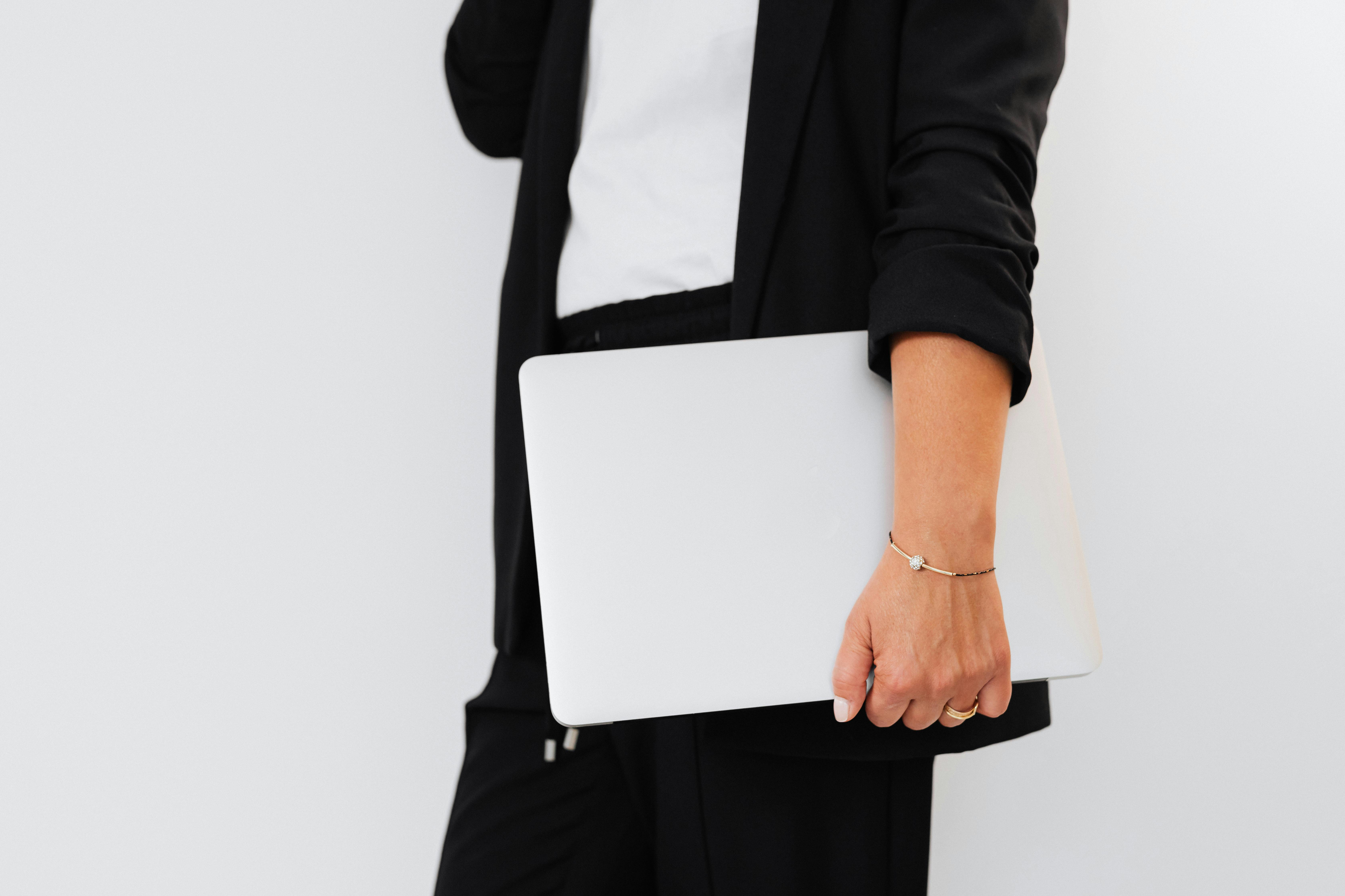 Hand Carrying a Laptop · Free Stock Photo