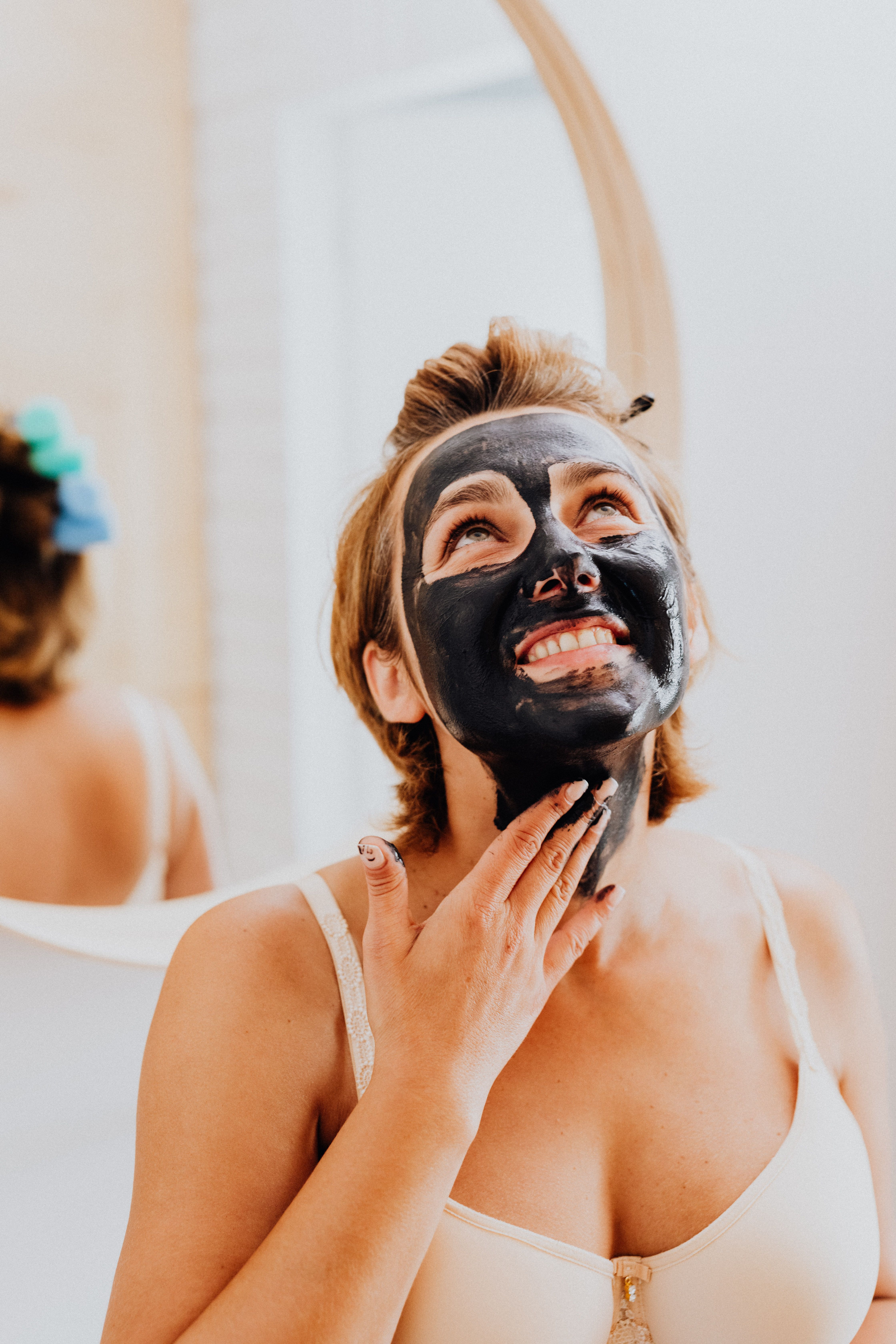 Woman with Cosmetic Mask on Her Face Looking Up · Free Stock Photo