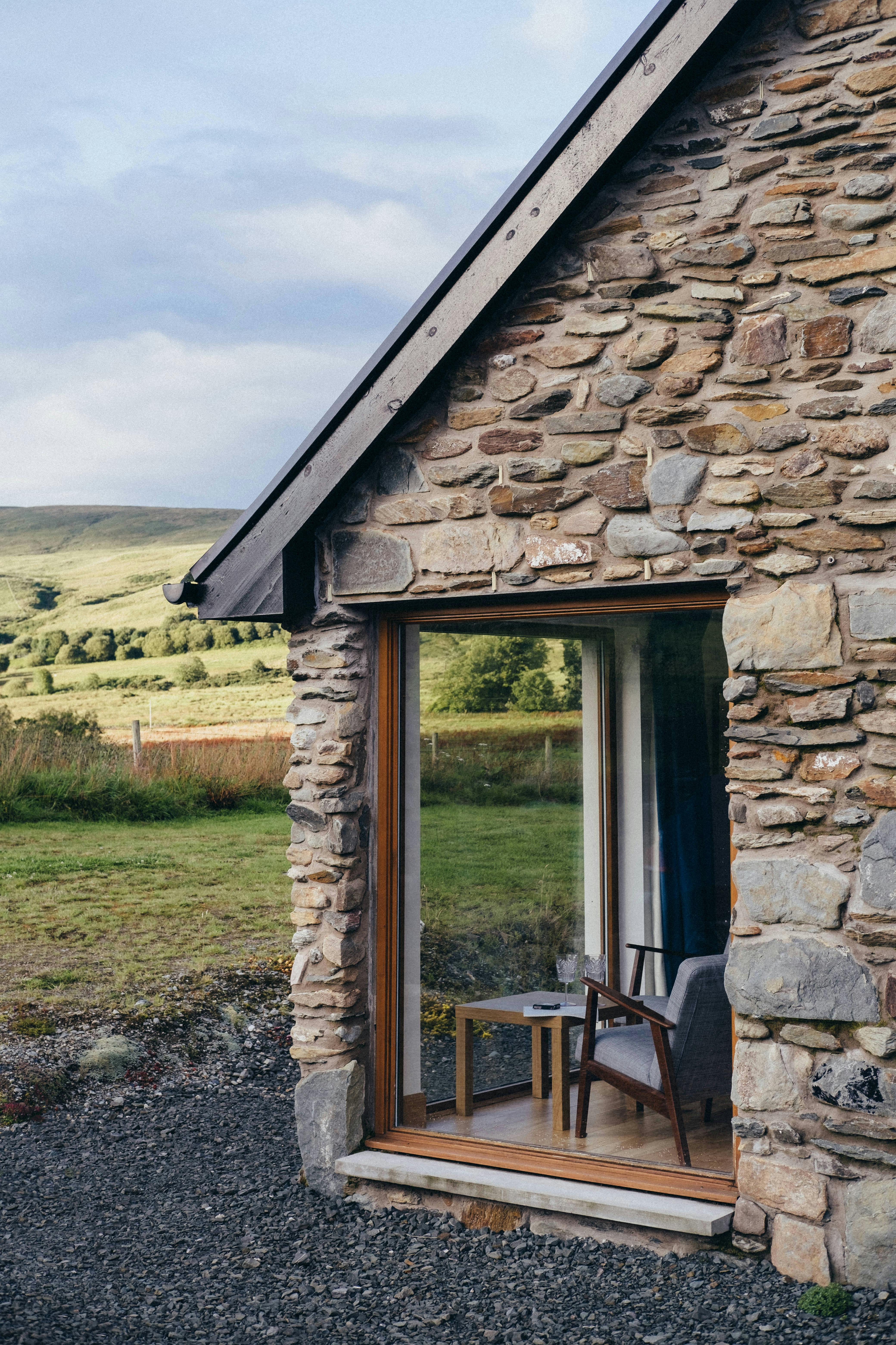 Stone house with glass walls in countryside · Free Stock Photo