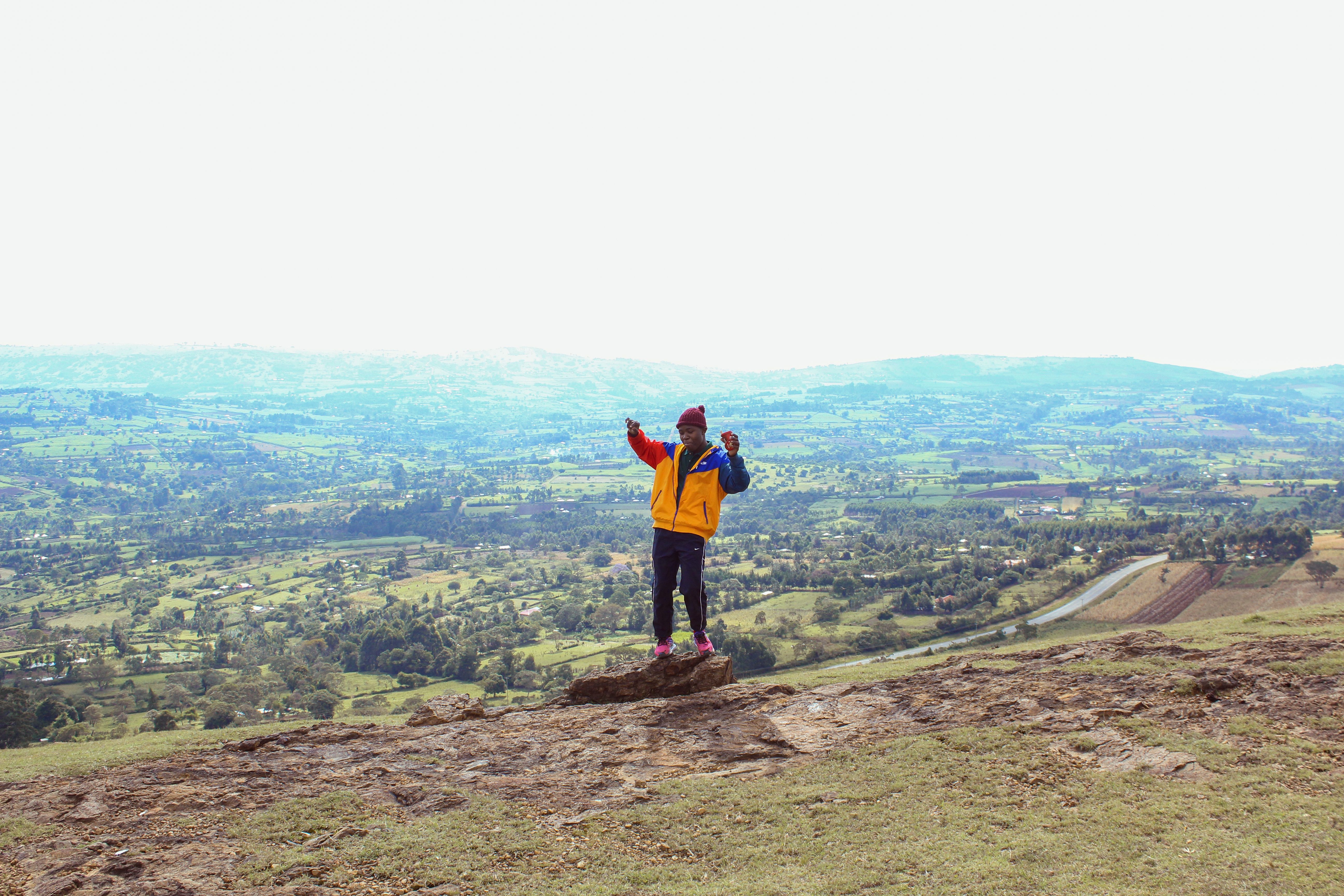 A Man in Jacket Standing on Big Rock on Top of a Mountain · Free Stock ...