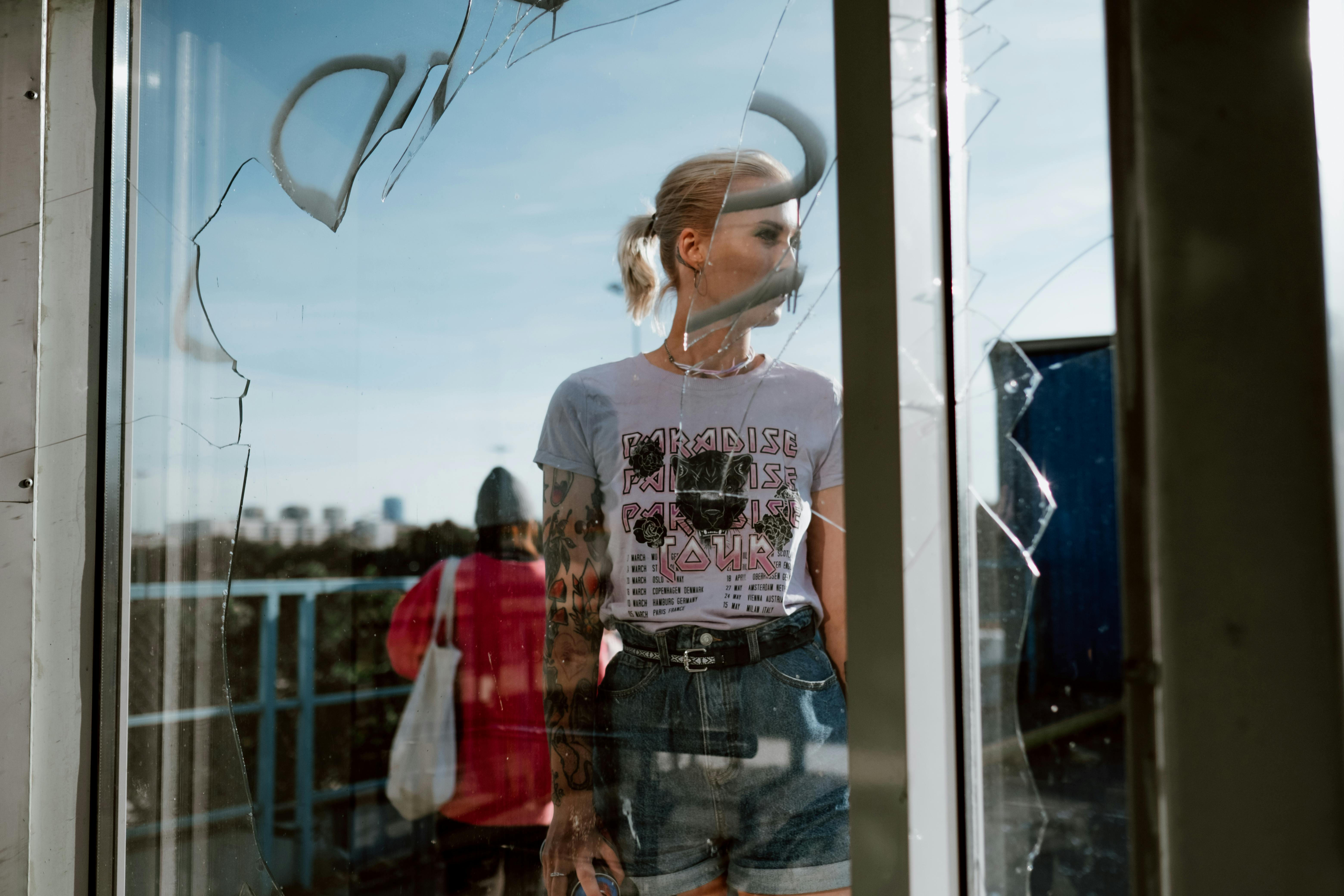 A Woman Standing near the Glass Window · Free Stock Photo