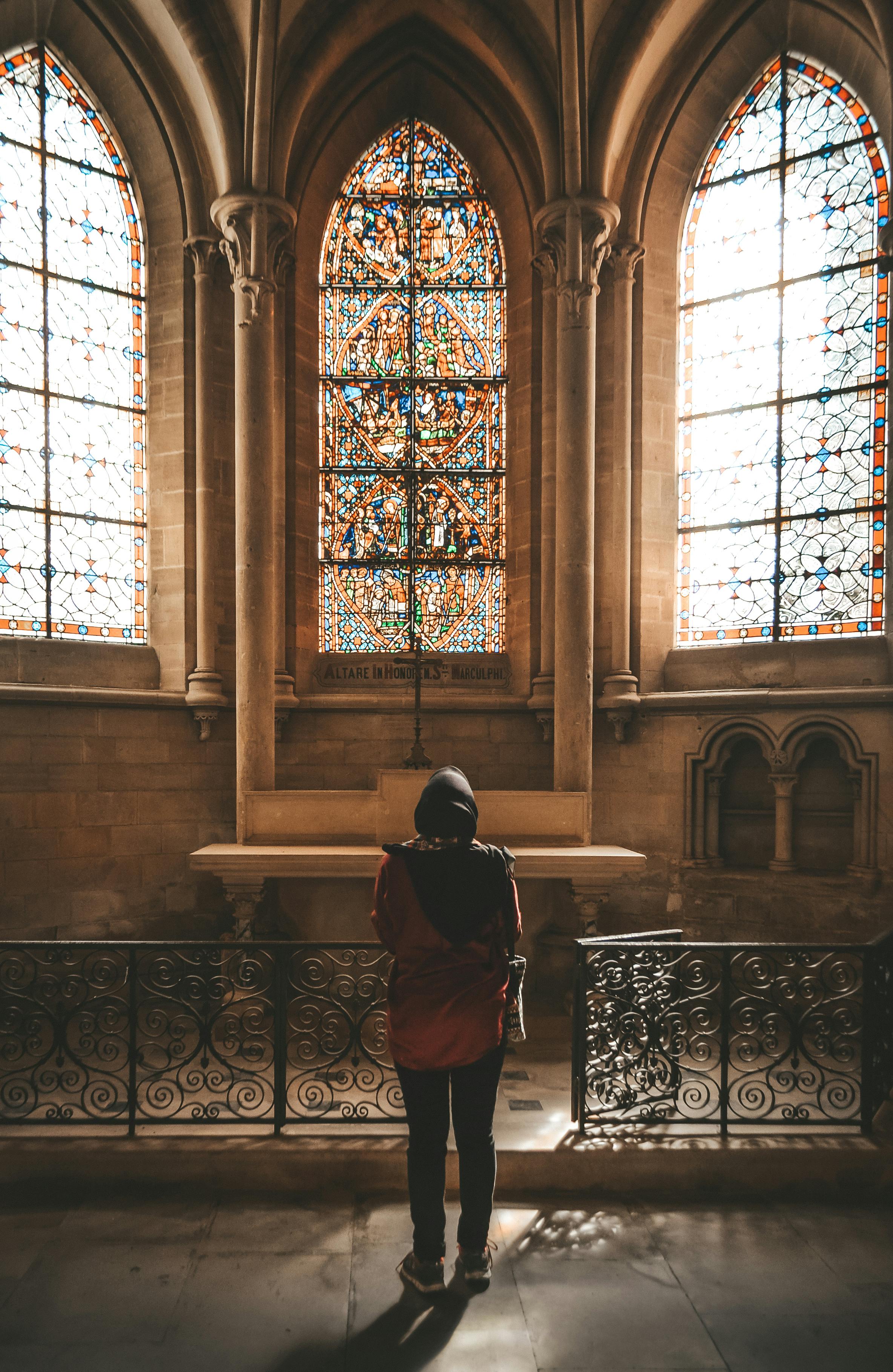 Back View of a Person Praying Inside a Church · Free Stock Photo