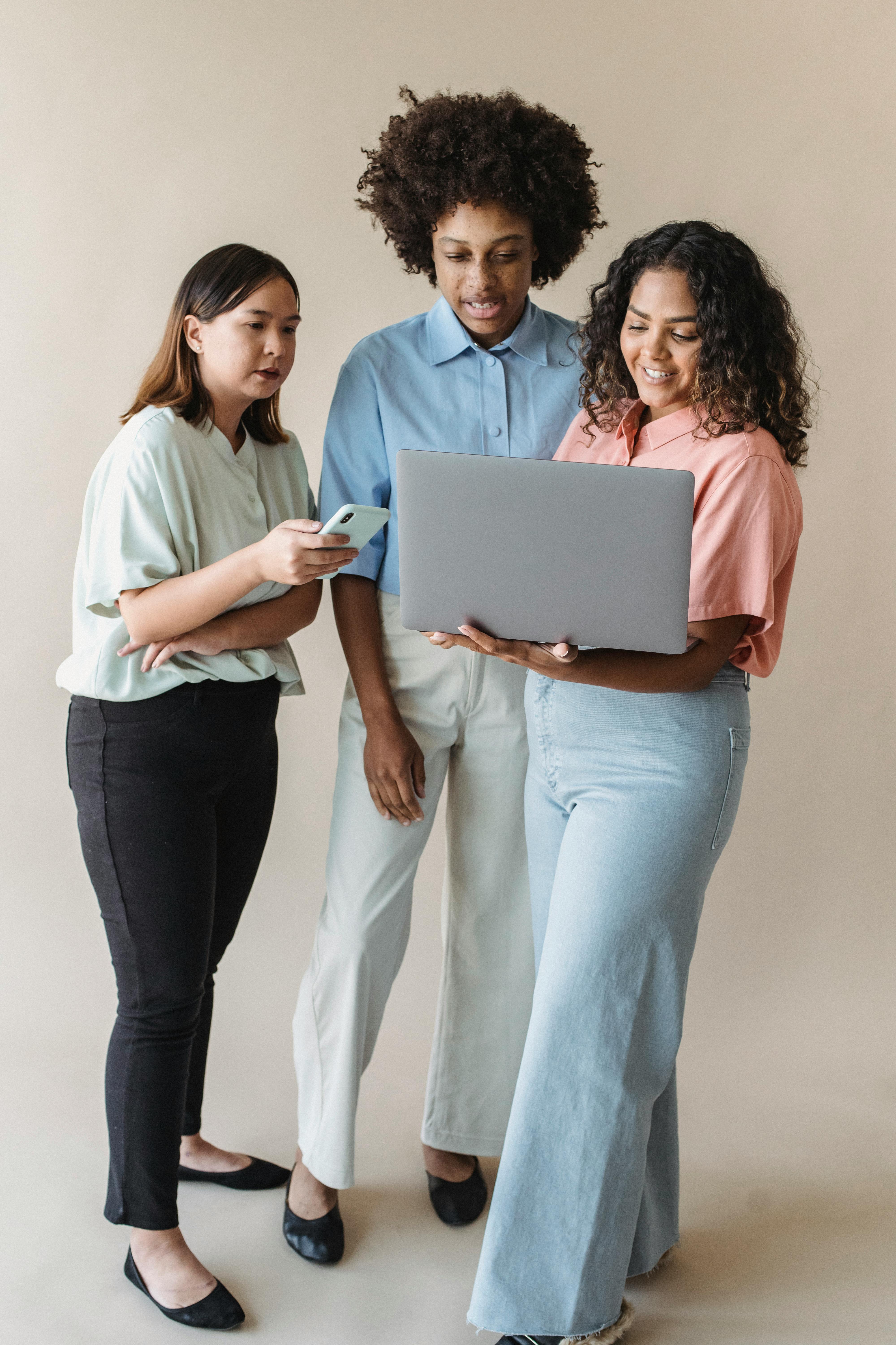 Women Standing with Laptop · Free Stock Photo