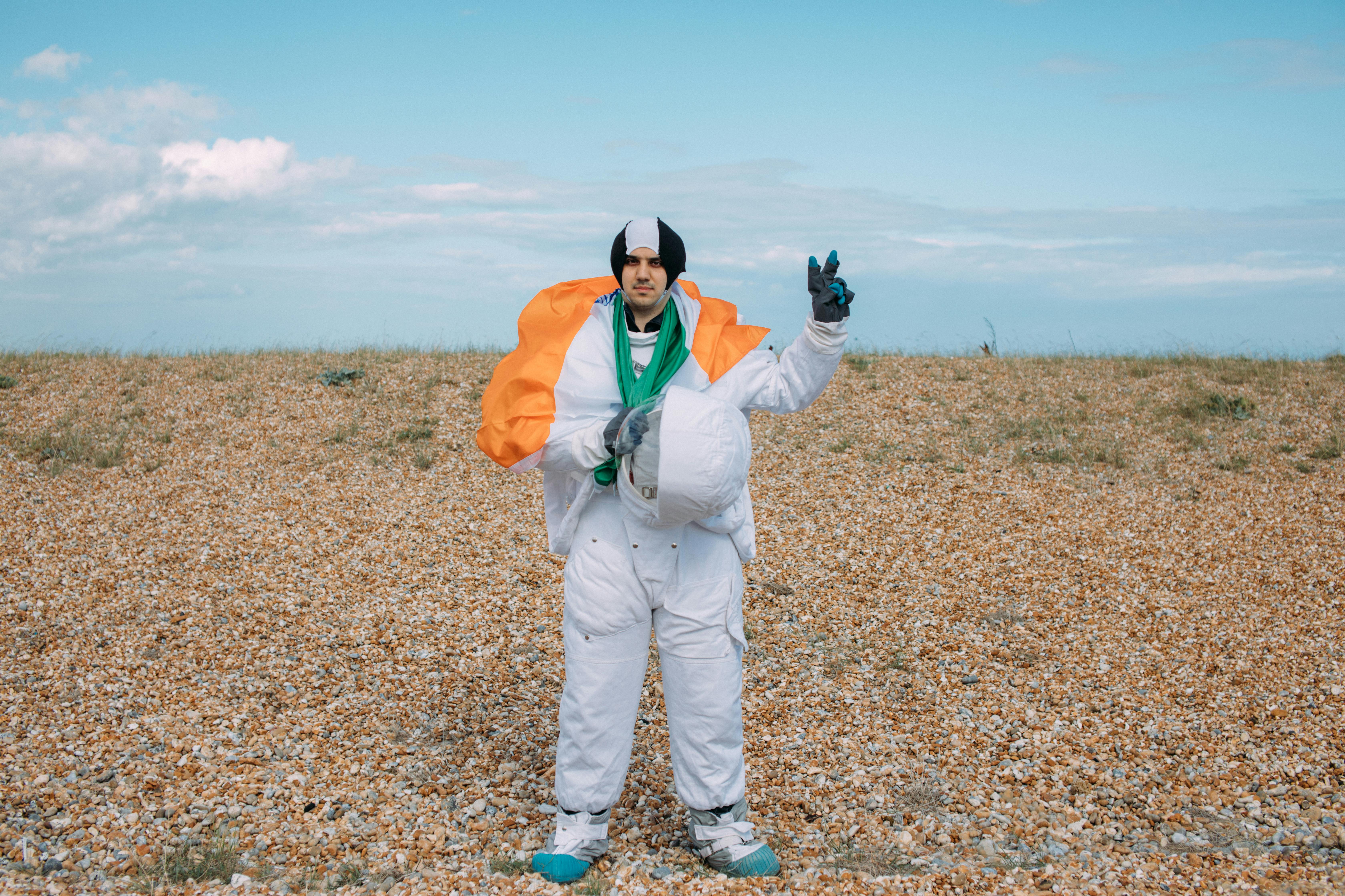 Man In An Astronaut Costume Doing A Peace Sign · Free Stock Photo