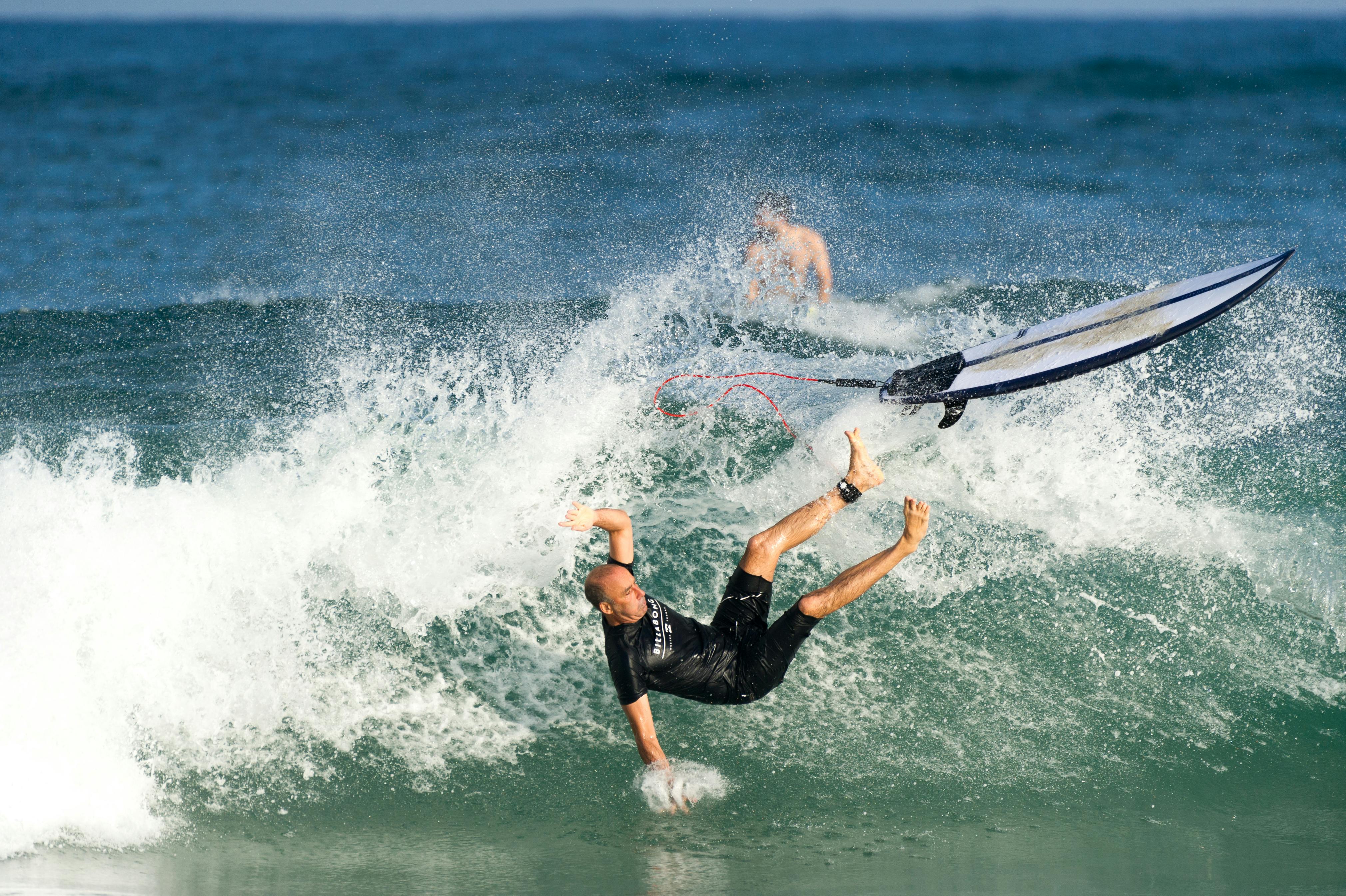 A Surfer Falling Off His Surfboard · Free Stock Photo