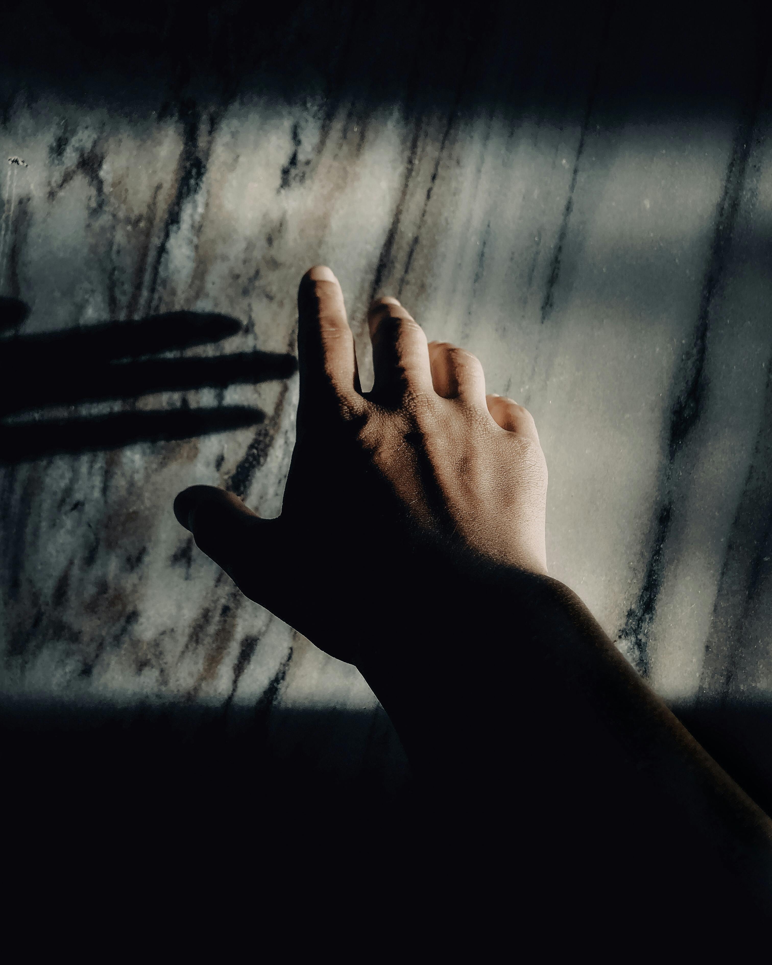 A Person Touching a Grave Stone · Free Stock Photo