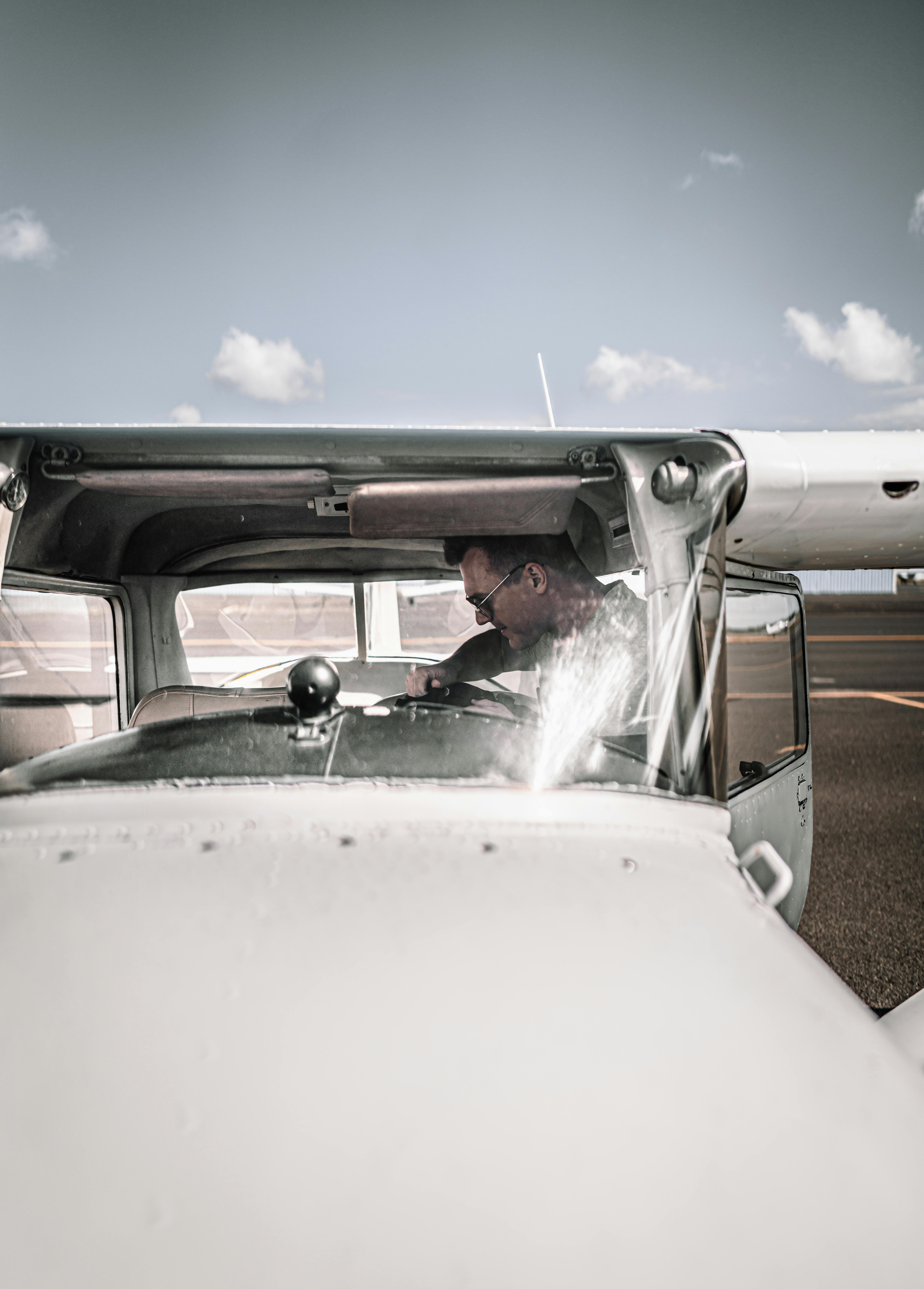 Young man sitting in contemporary two seat aircraft on aerodrome · Free ...