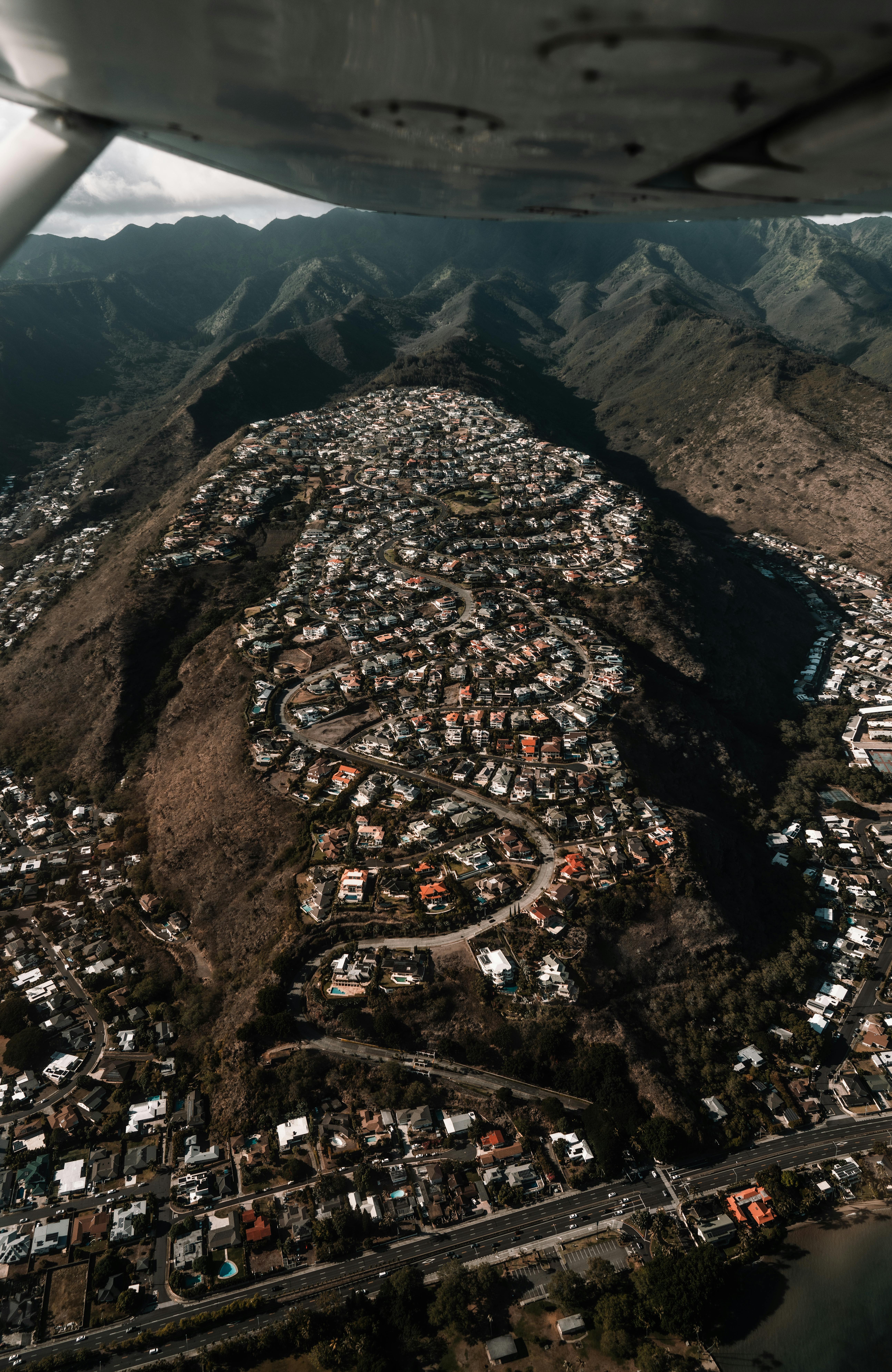 Hot air balloon flying over town · Free Stock Photo