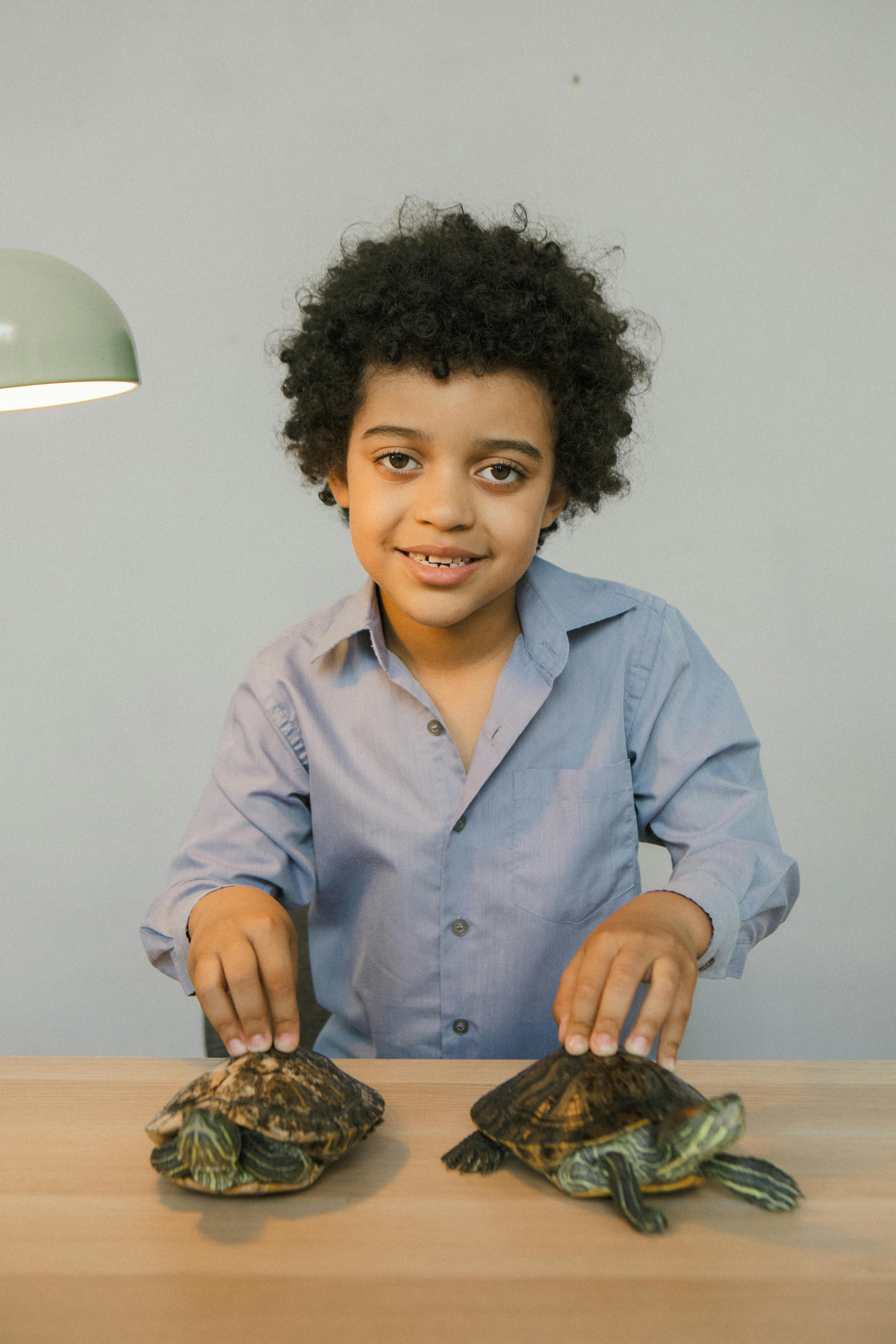 Portrait of a Boy with Pet Tortoises · Free Stock Photo
