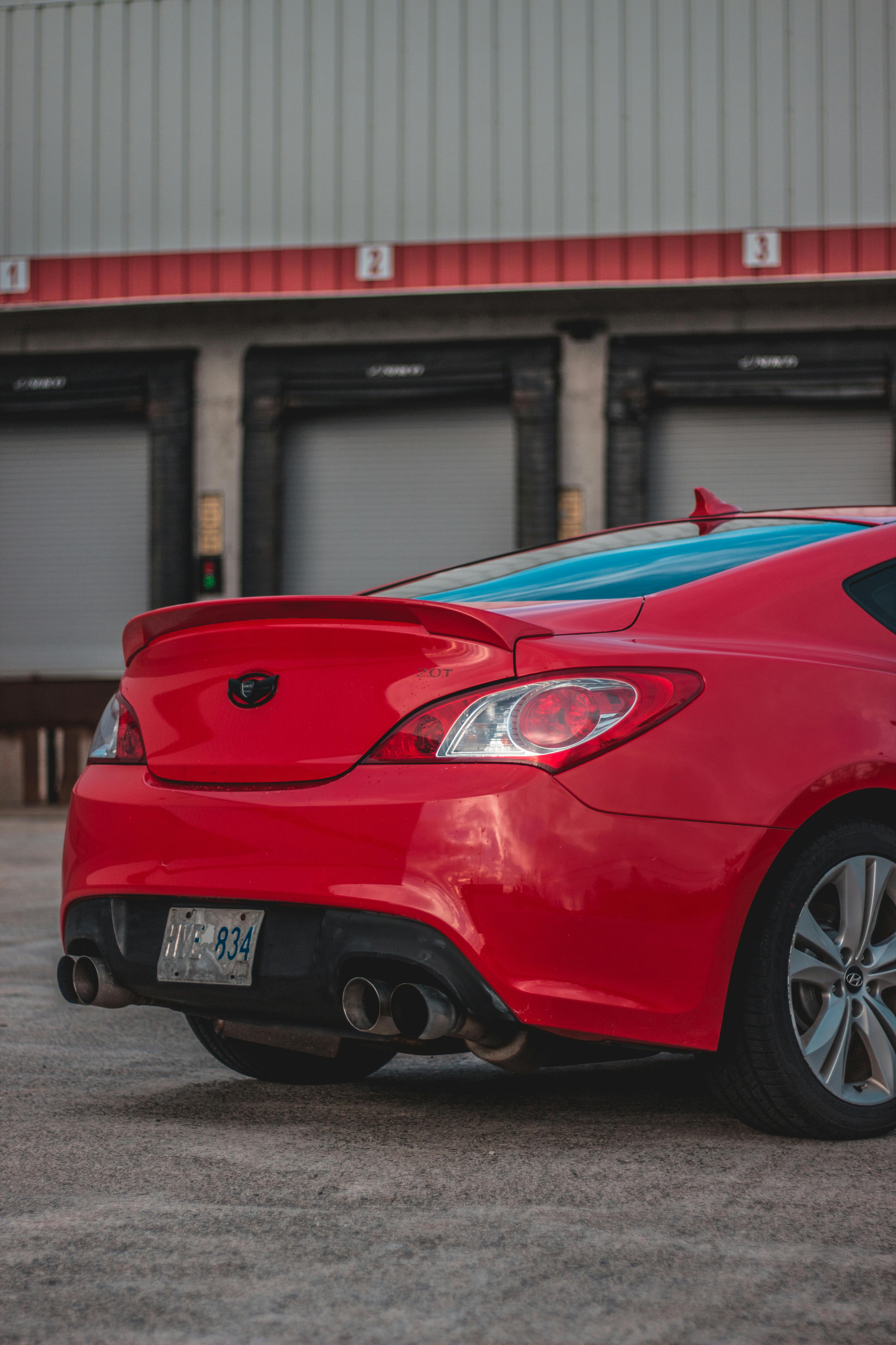 A Red Sedan Car Parked on the Road · Free Stock Photo