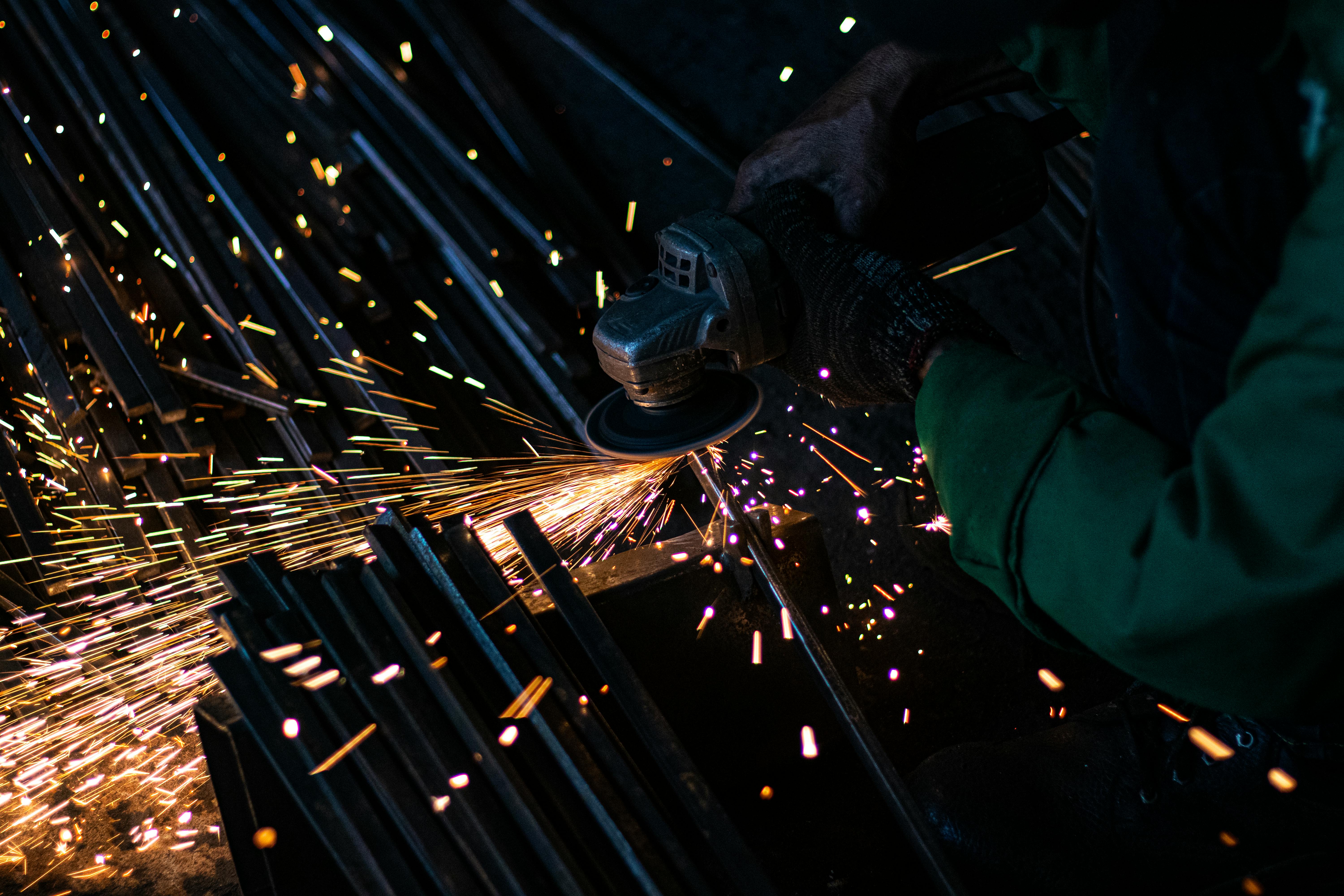 A Person Grinding a Metal · Free Stock Photo