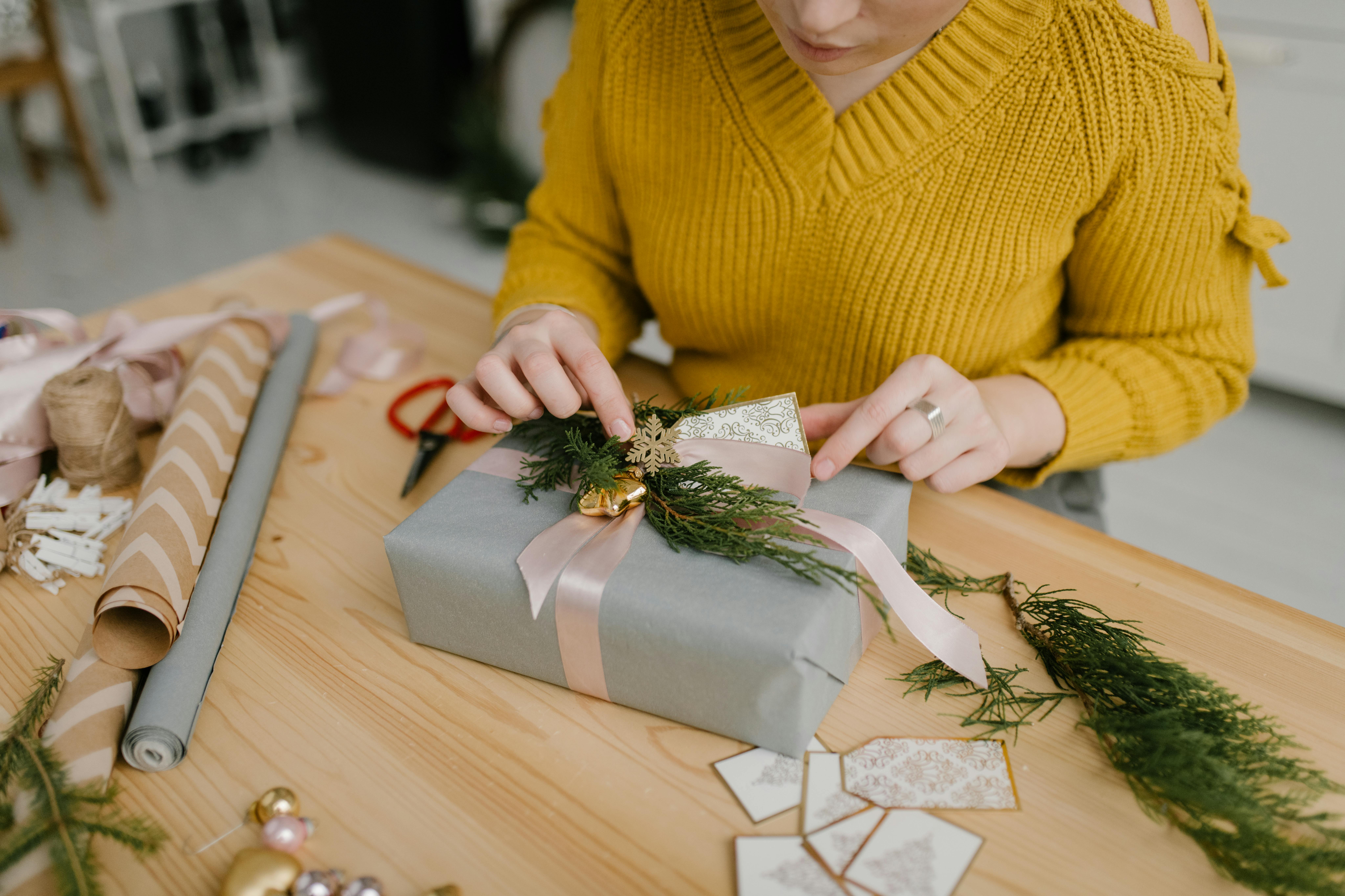 Close-Up Shot of a Person Wrapping a Gift · Free Stock Photo