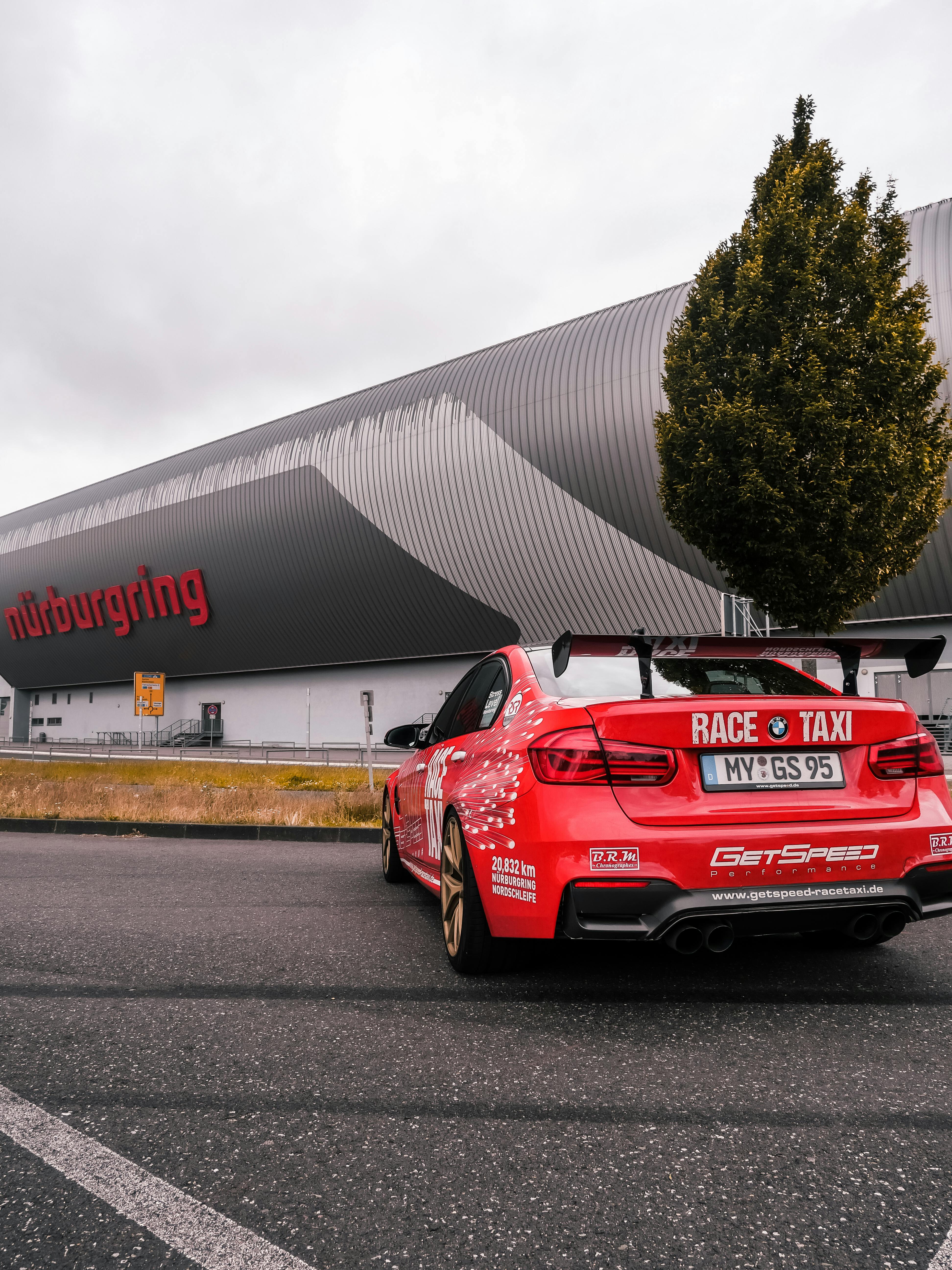 A Red Sports Car Parked on the Road · Free Stock Photo