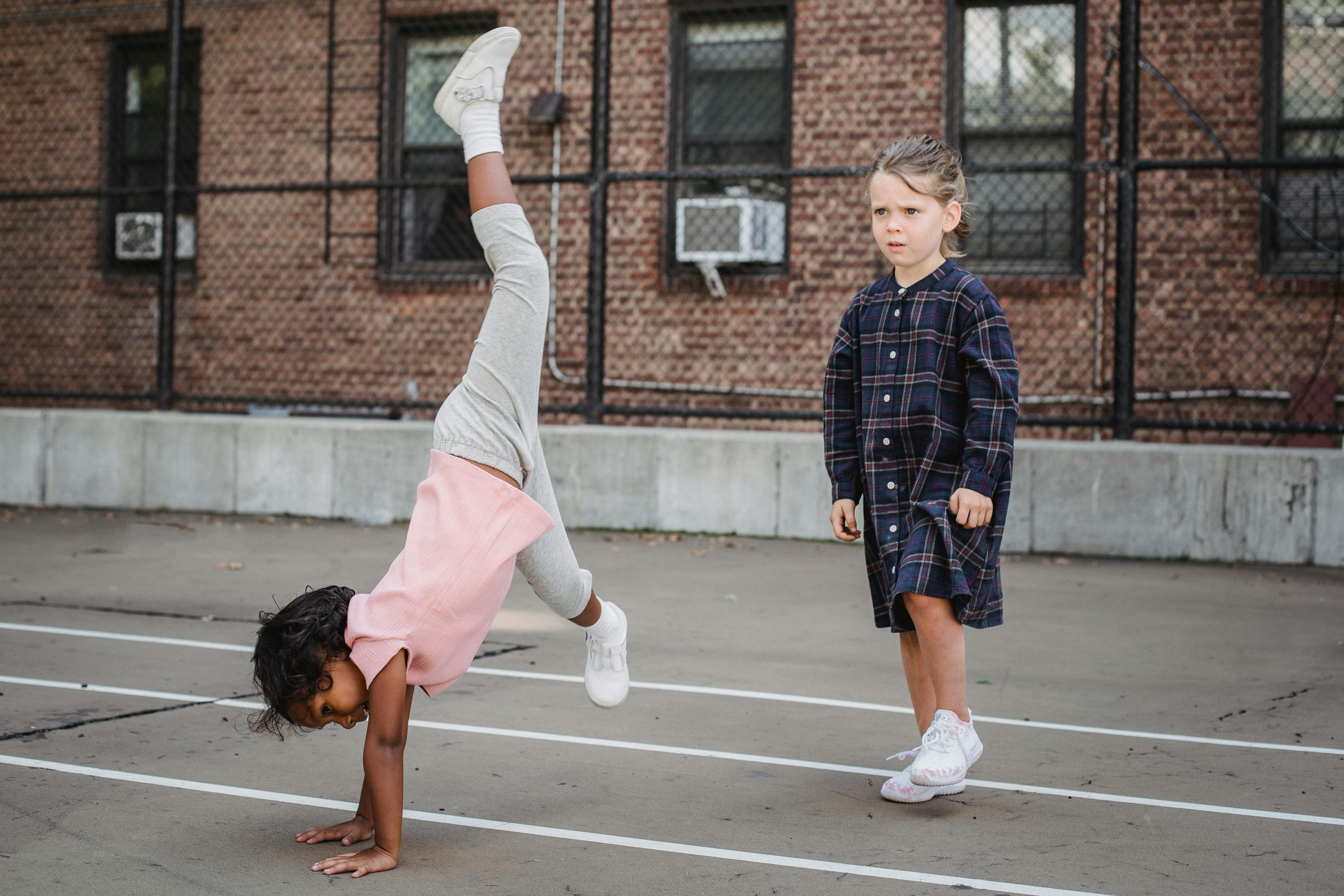 Girl in Pink Shirt Doing Cartwheel · Free Stock Photo
