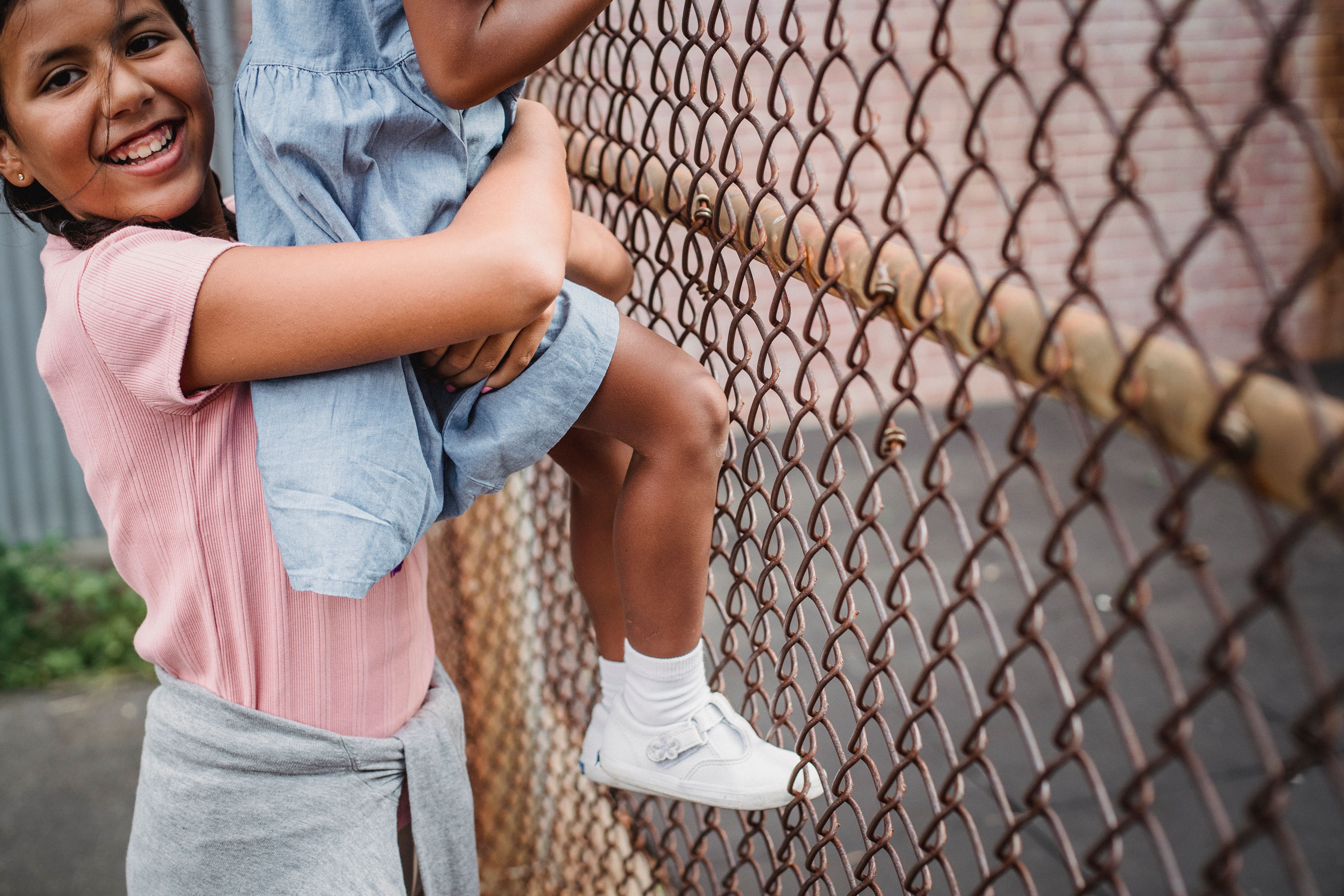 Children Playing by Fence · Free Stock Photo