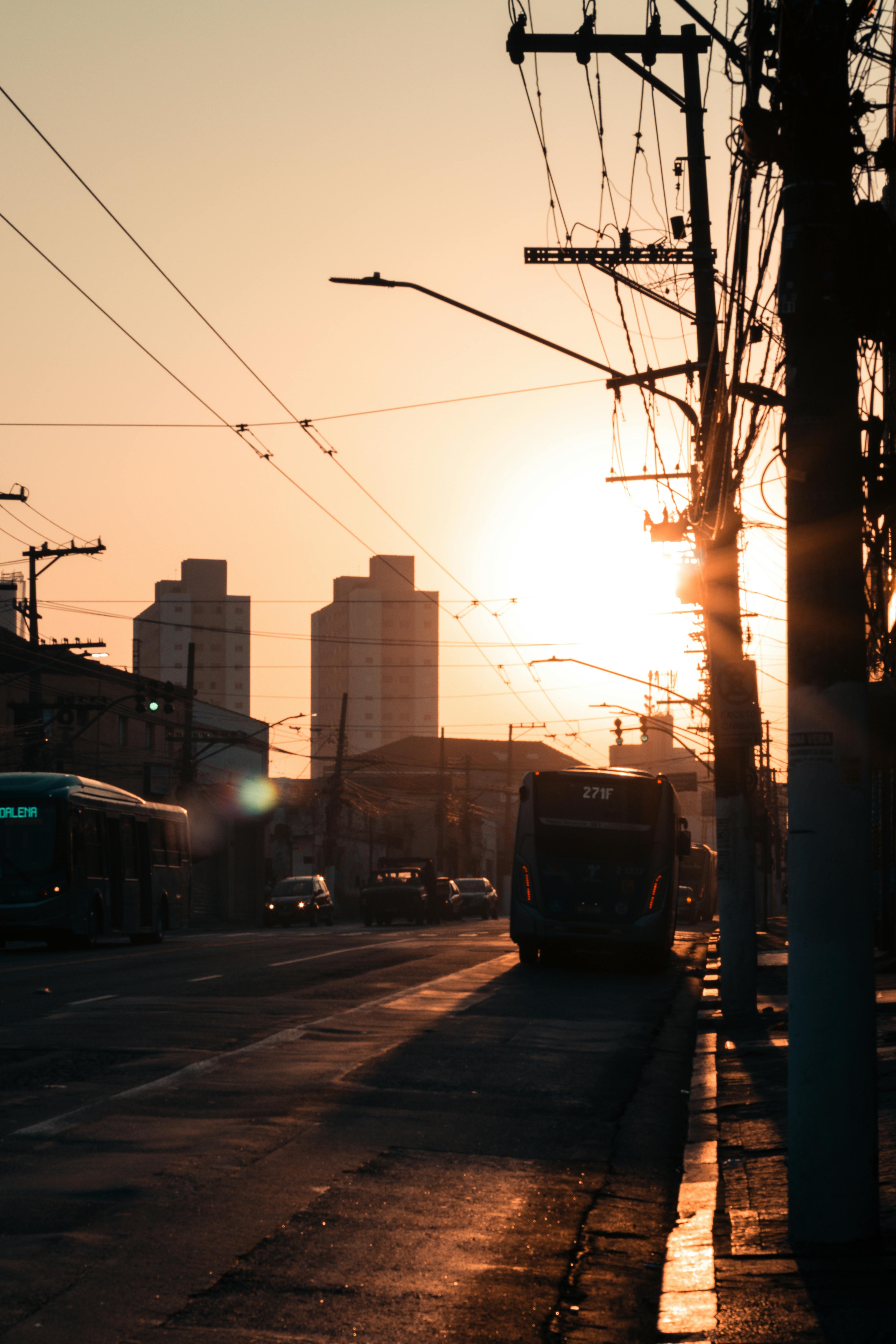Modern city street with traffic at sunset · Free Stock Photo