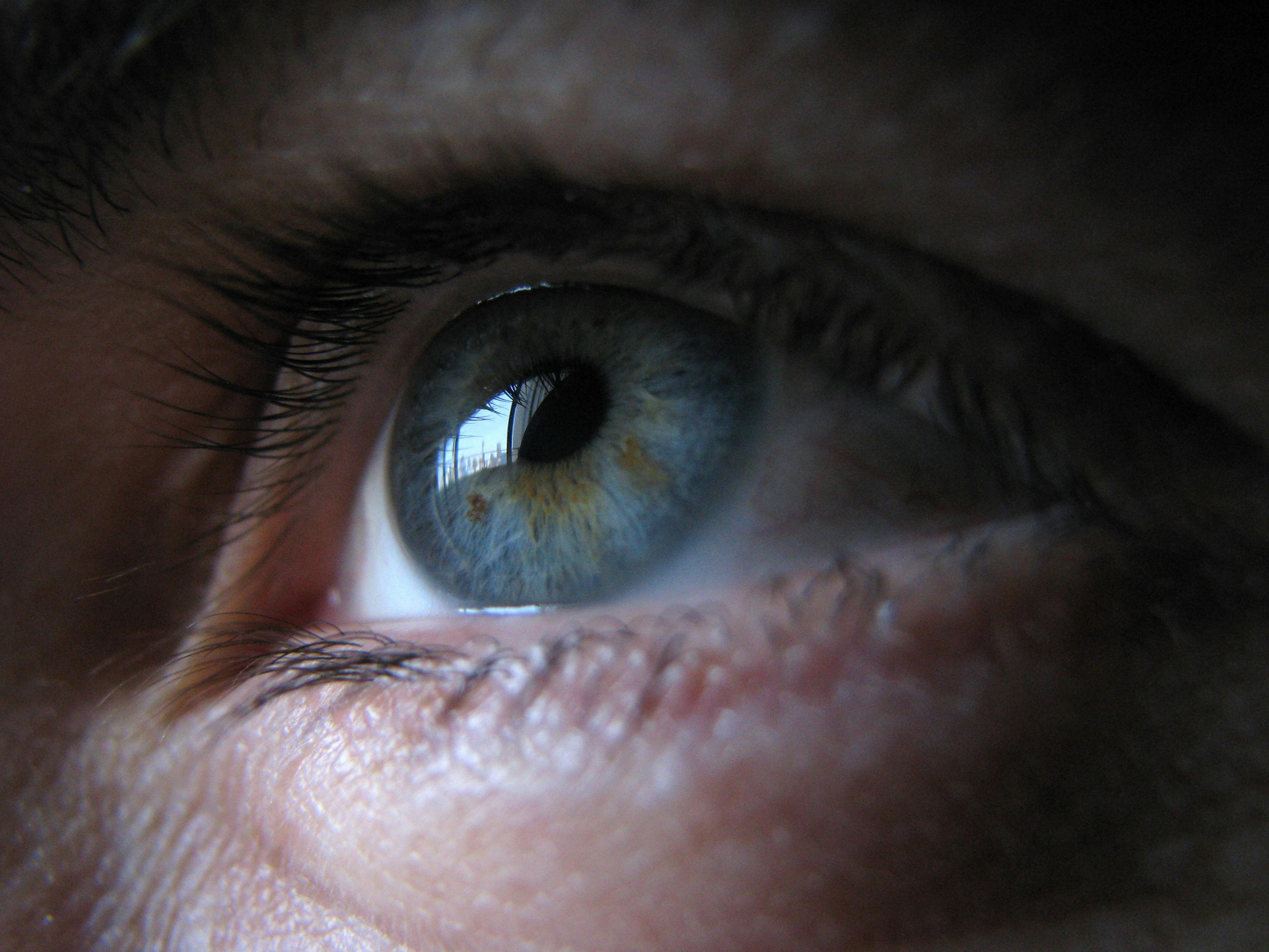 Person's Eye near Lighted Candle · Free Stock Photo
