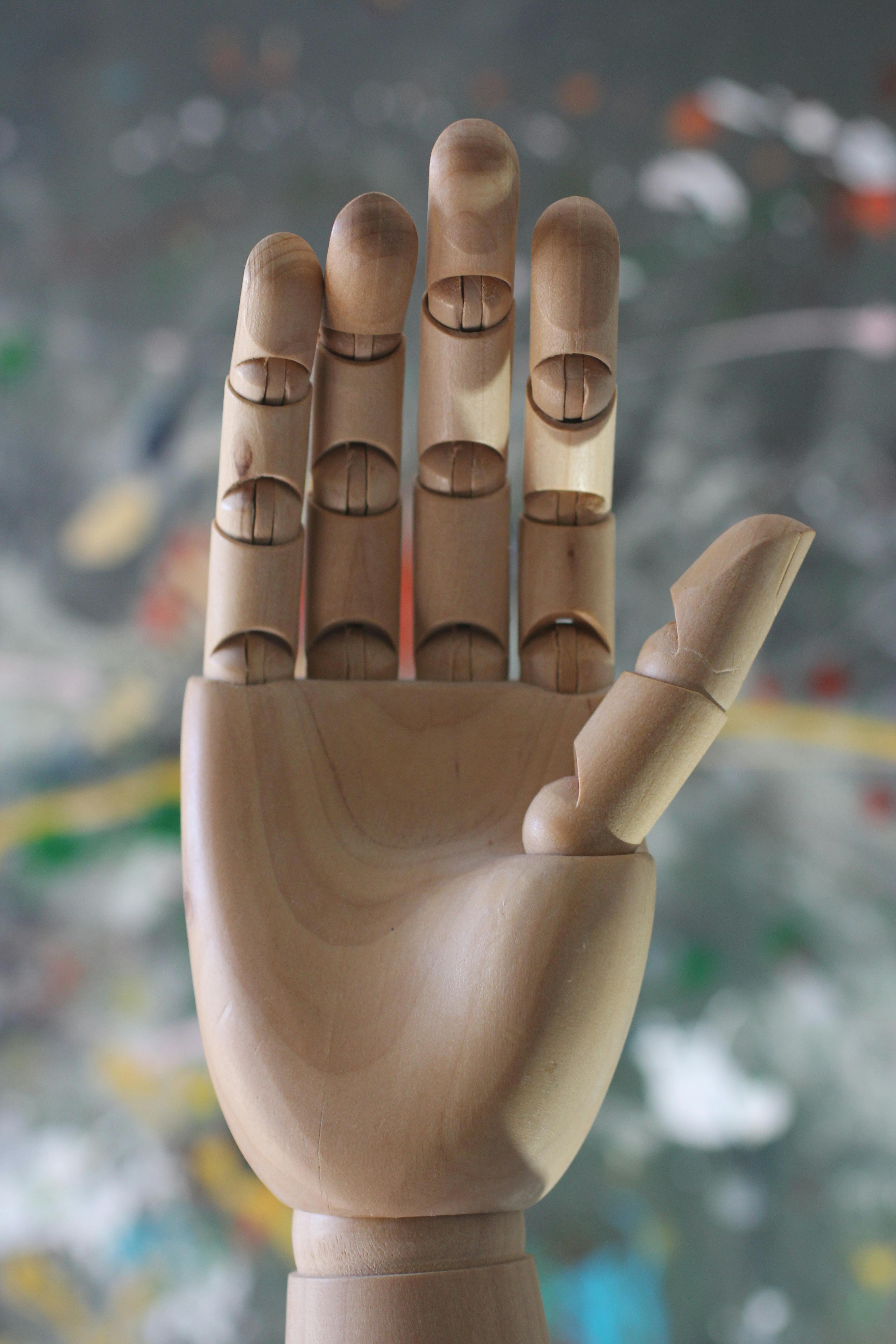 A Wooden Flexible Human Hand Figurine · Free Stock Photo
