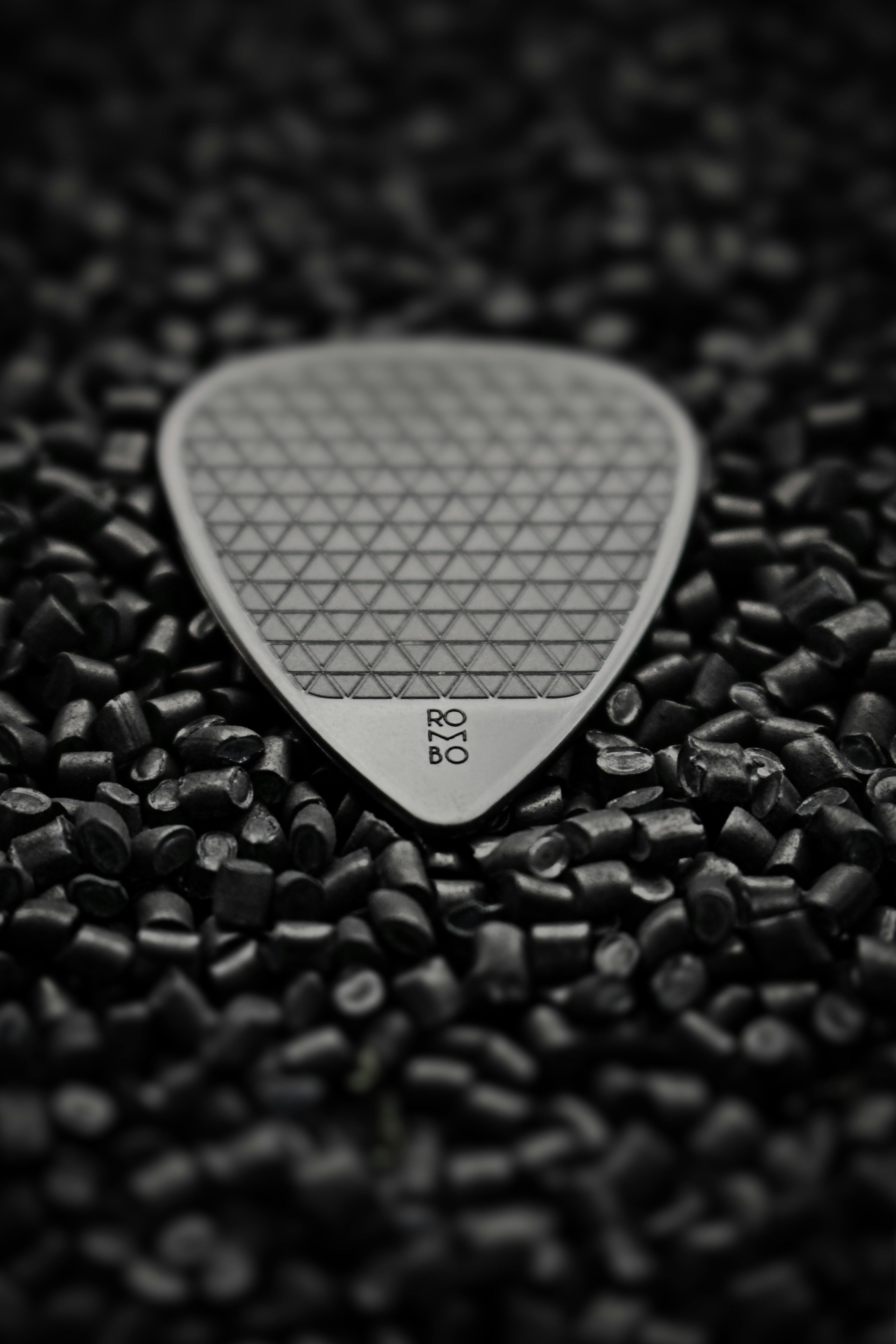 Close-up Shot of a Steel Guitar Pick · Free Stock Photo