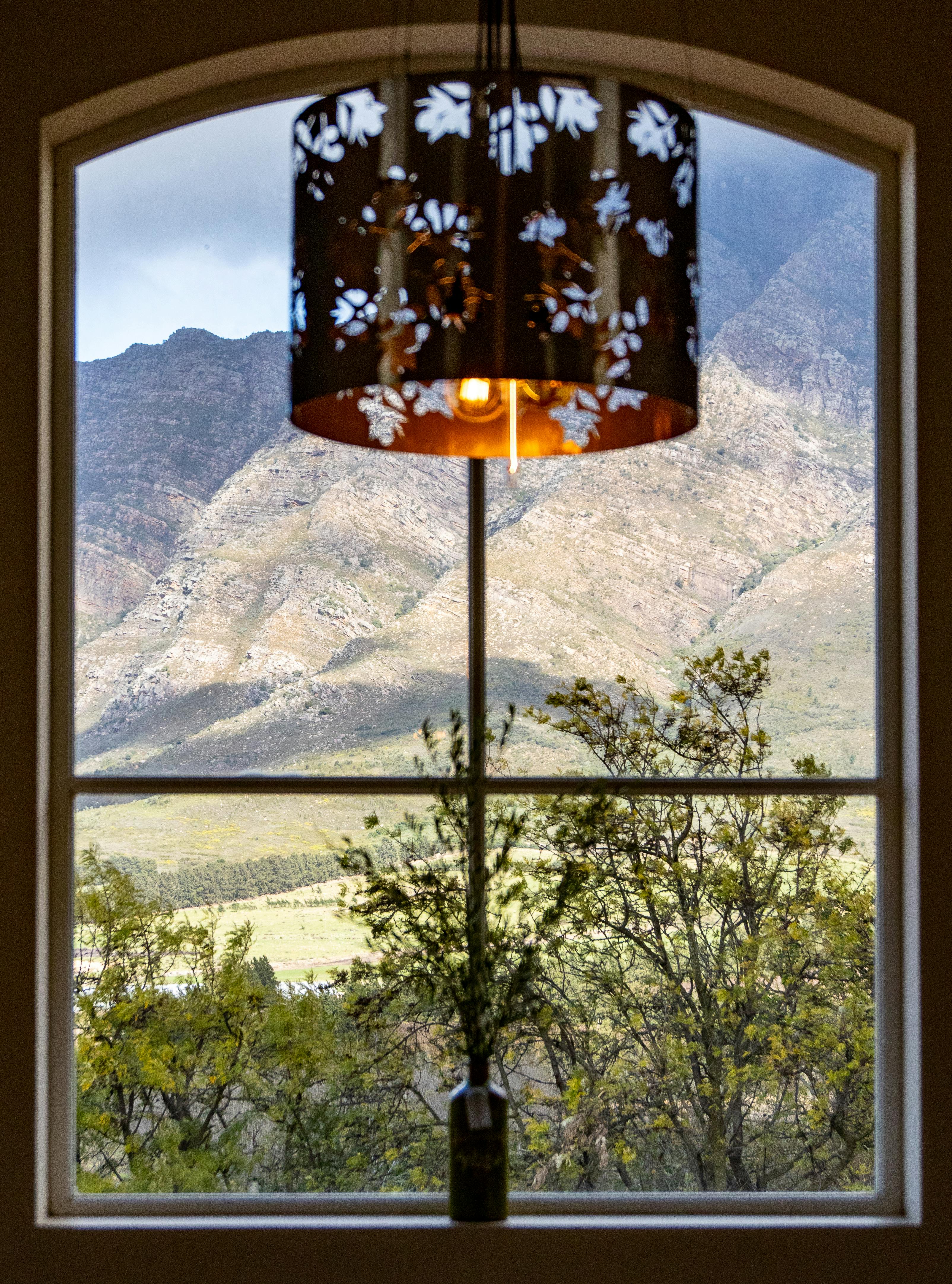 A Scenic View of a Mountain Through a Glass Window · Free Stock Photo