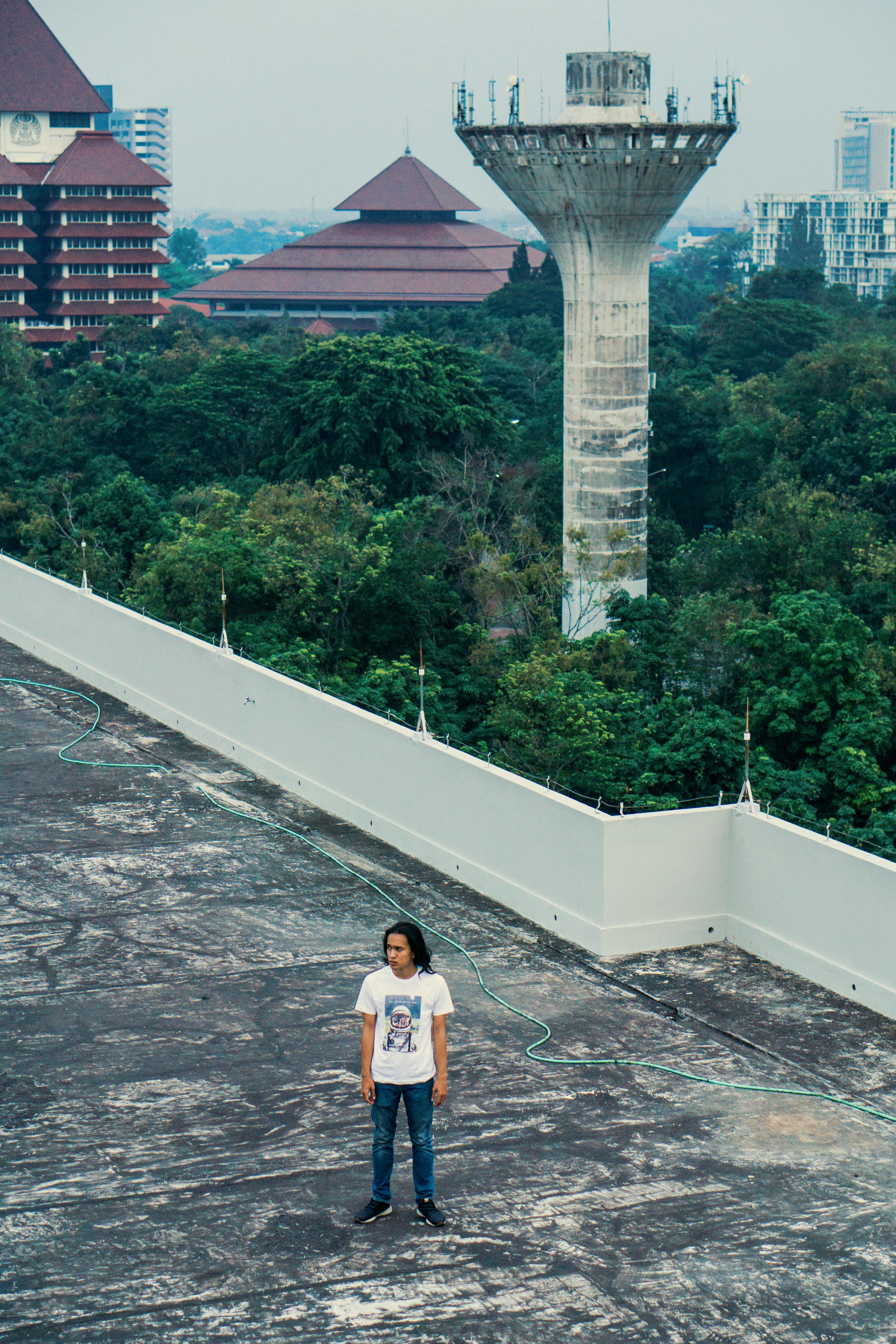 A Man Standing on the Roof Top · Free Stock Photo