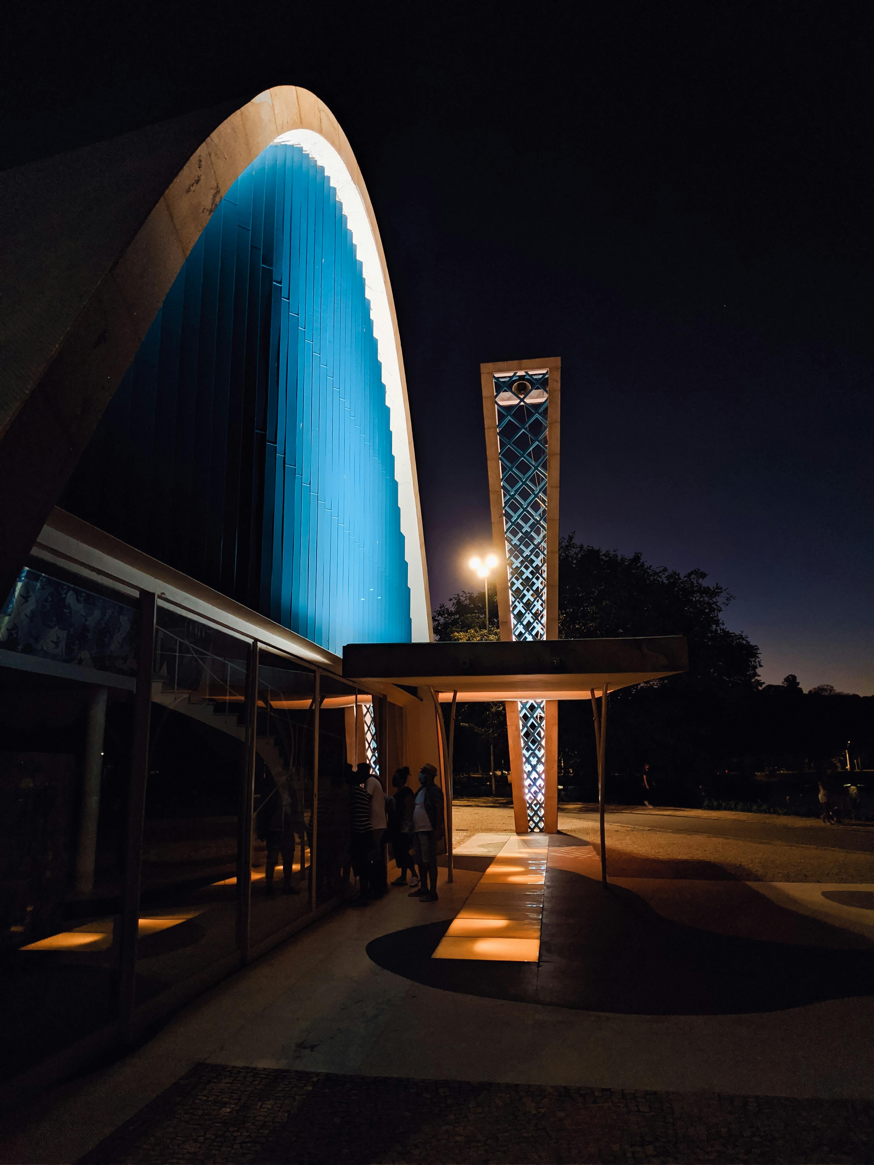 People In Front Of Illuminated Blue Building At Night · Free Stock Photo