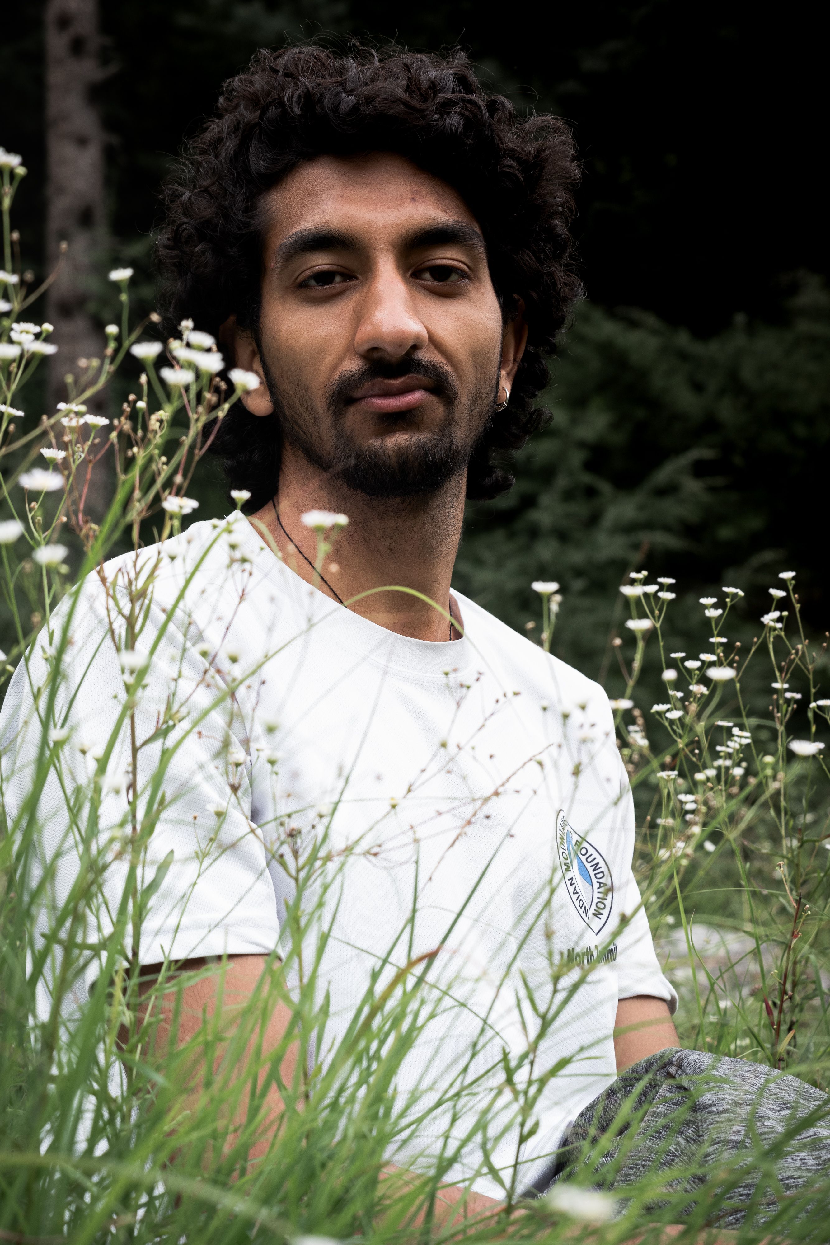 Man in White Crew Neck Shirt Standing Near Grass · Free Stock Photo