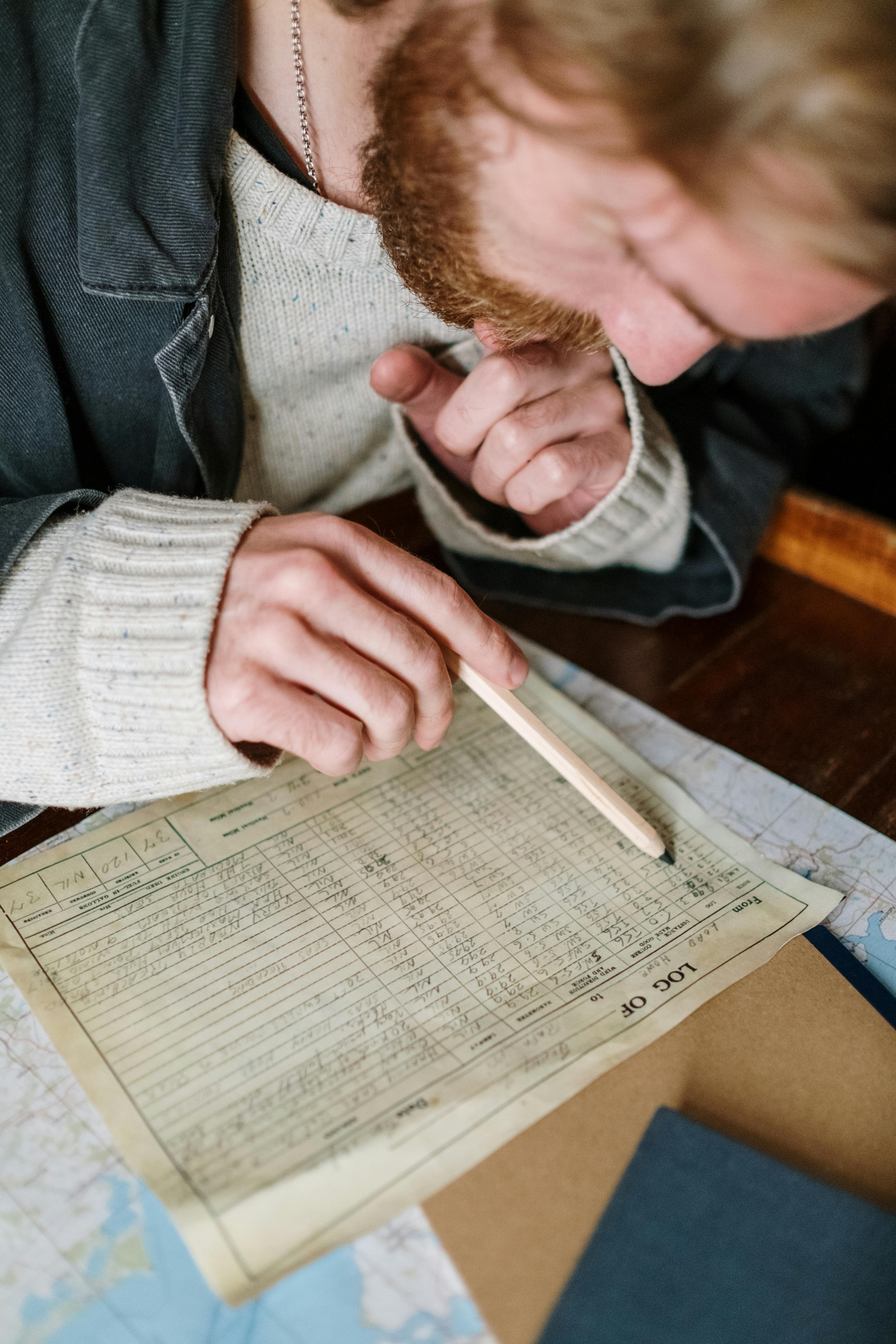 Focused Man looking at a Paper · Free Stock Photo