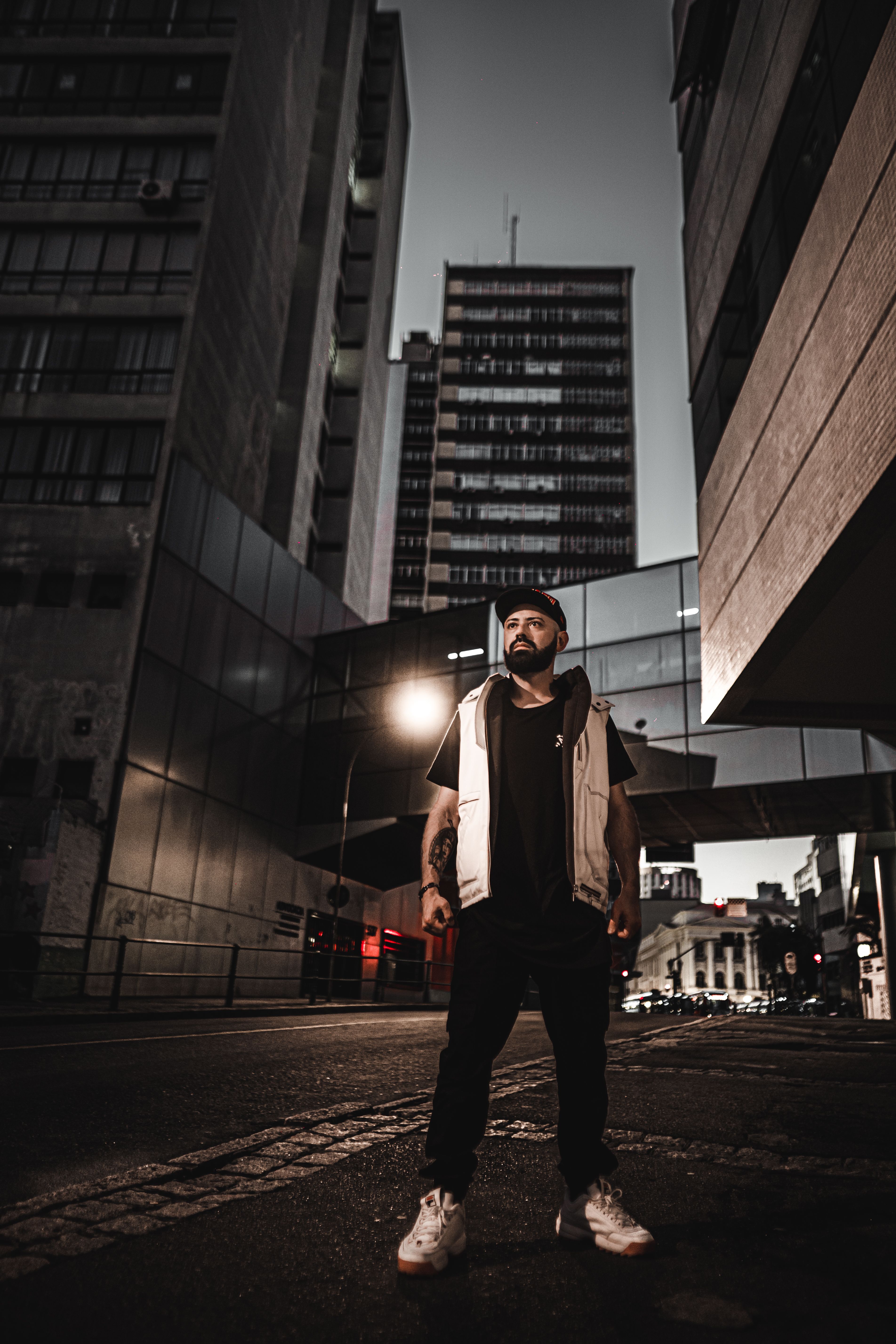 A Man Standing on Top of Building during Nighttime · Free Stock Photo