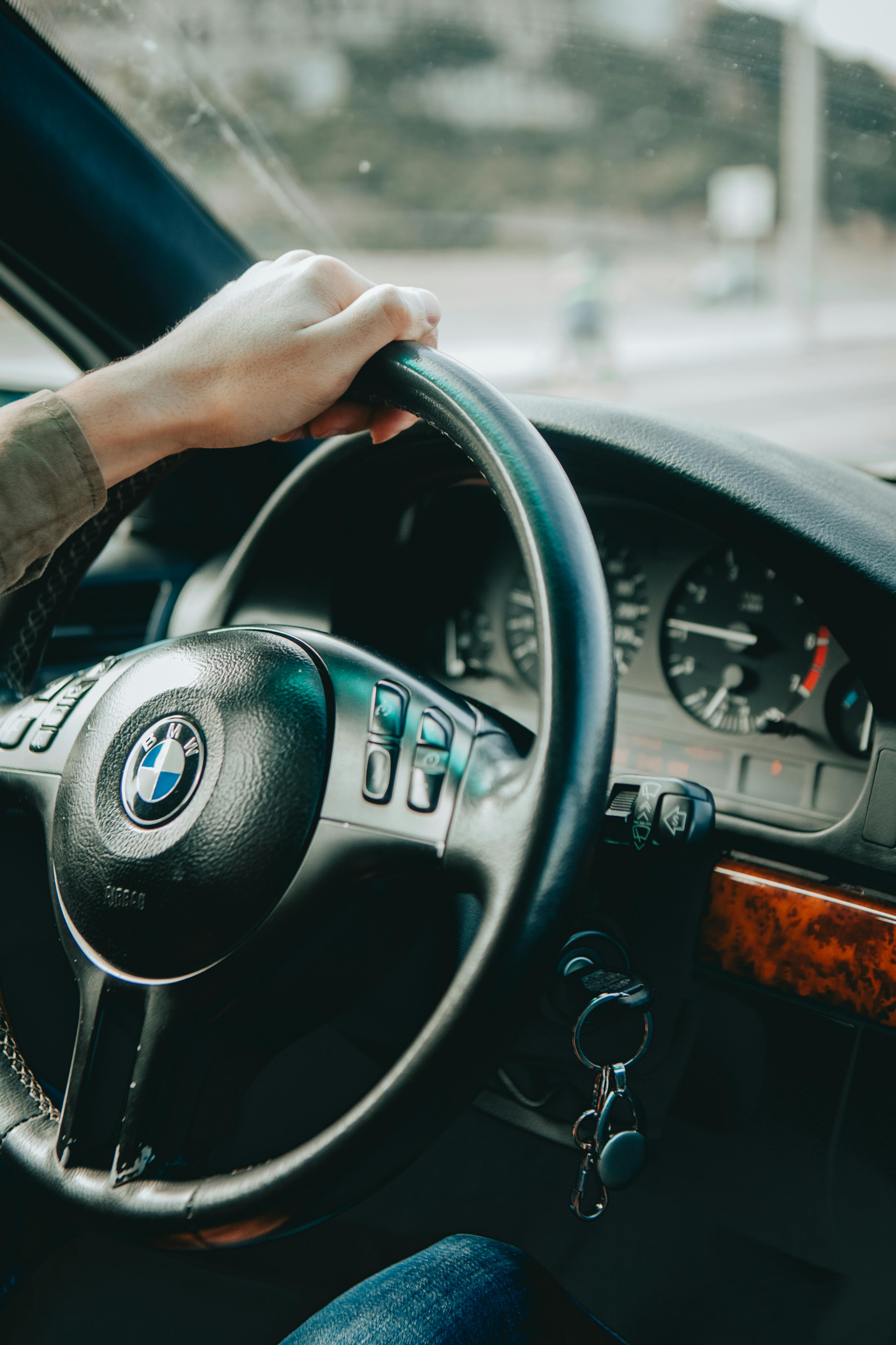 Person Inside a Car Holding the Steering Wheel · Free Stock Photo