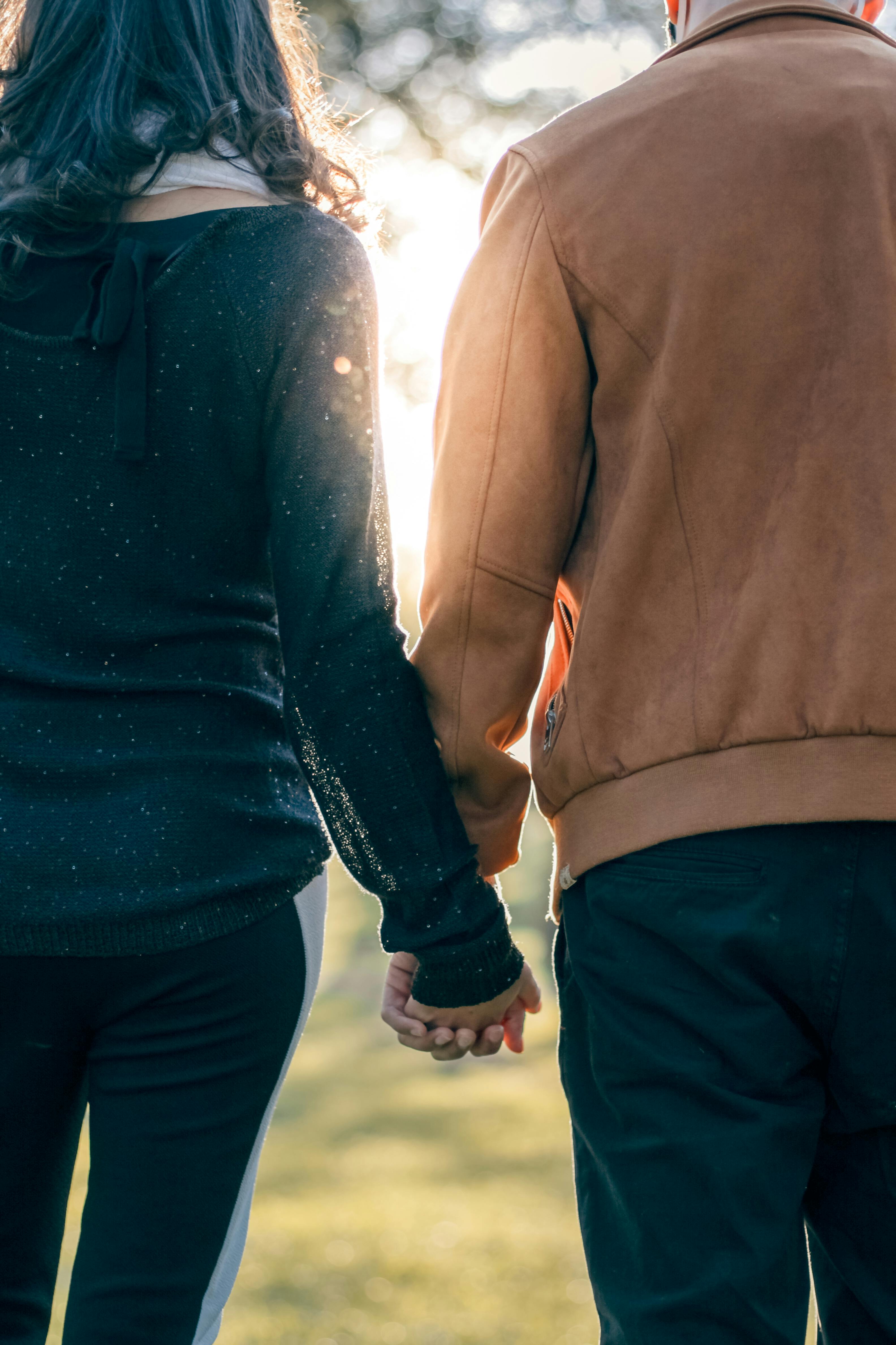 Back View of Couple Holding Hands · Free Stock Photo