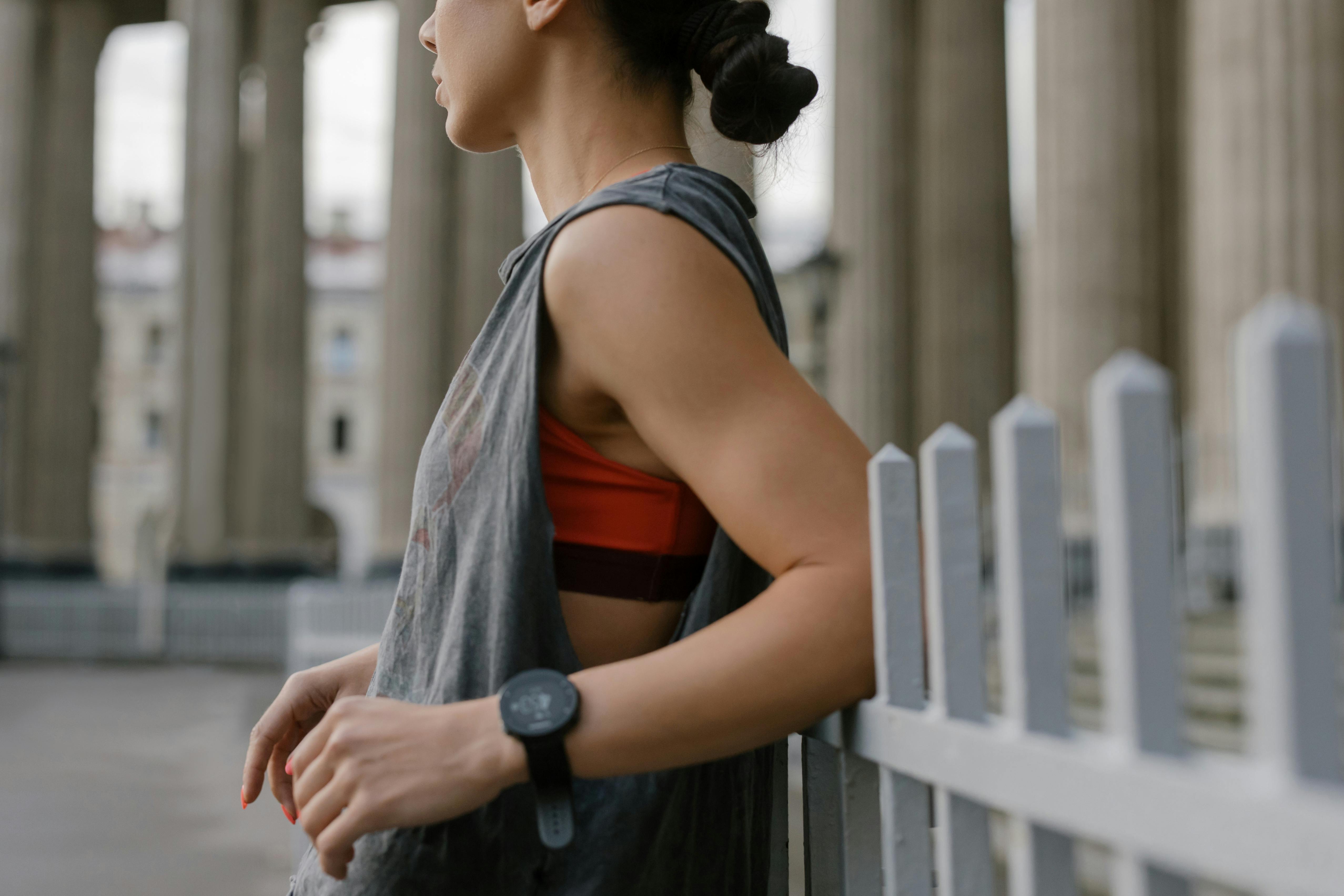 A Woman Wearing a Black Top and Eyeglasses Leaning on a Ledge · Free ...