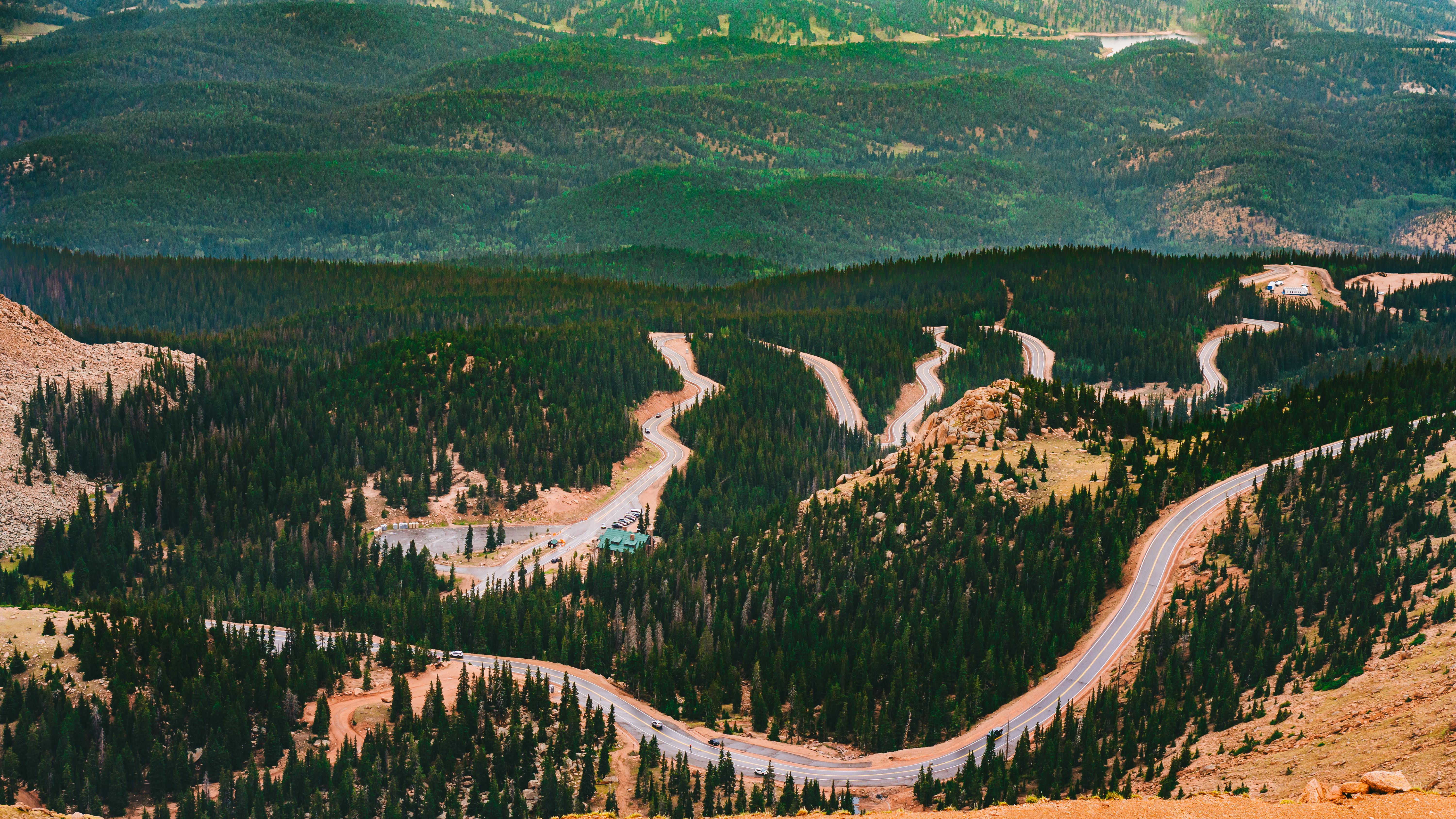 Rolling Landscape with Green Forests and Winding Roads on Orange Soil ...