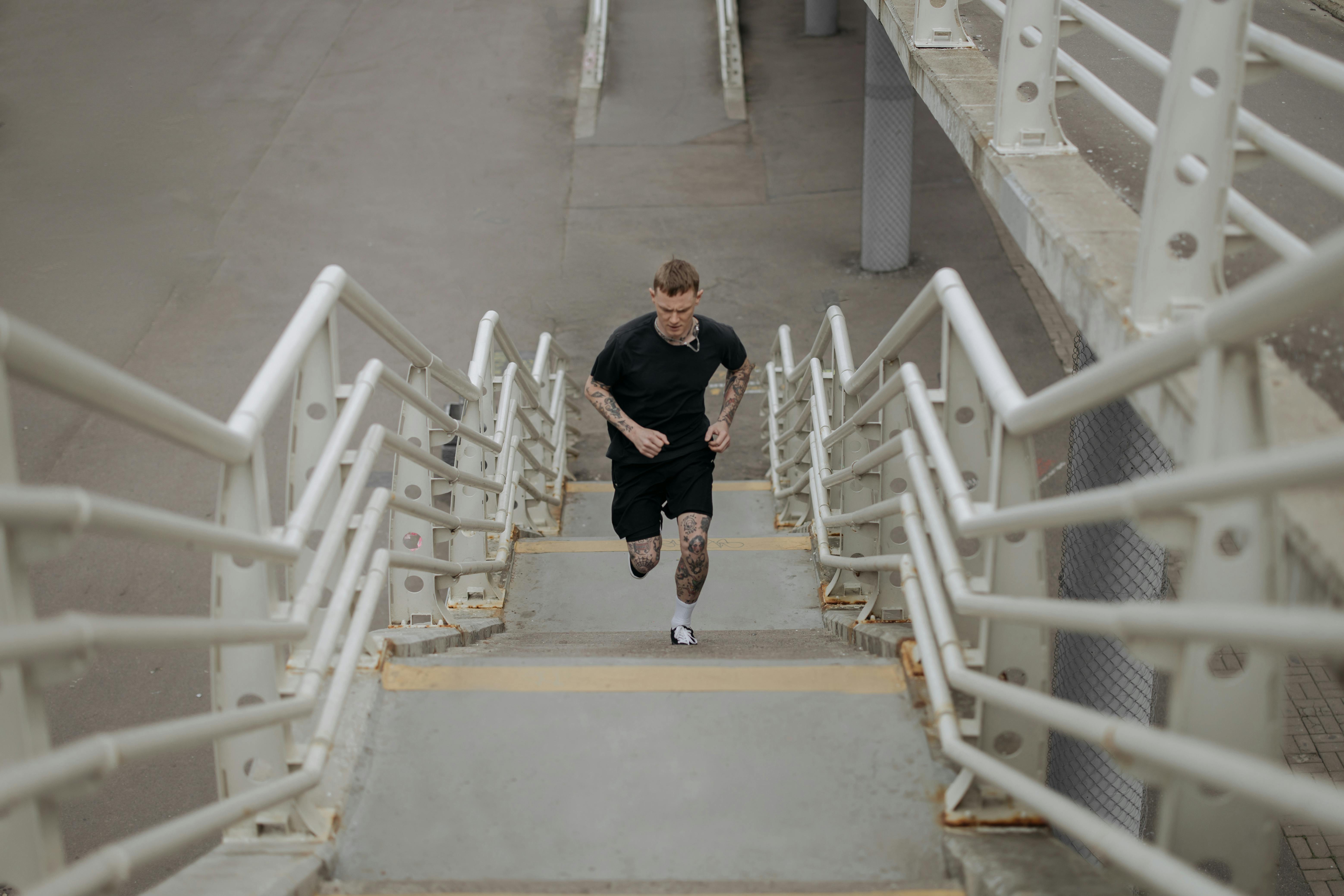 A Man Running on Concrete Stairs · Free Stock Photo