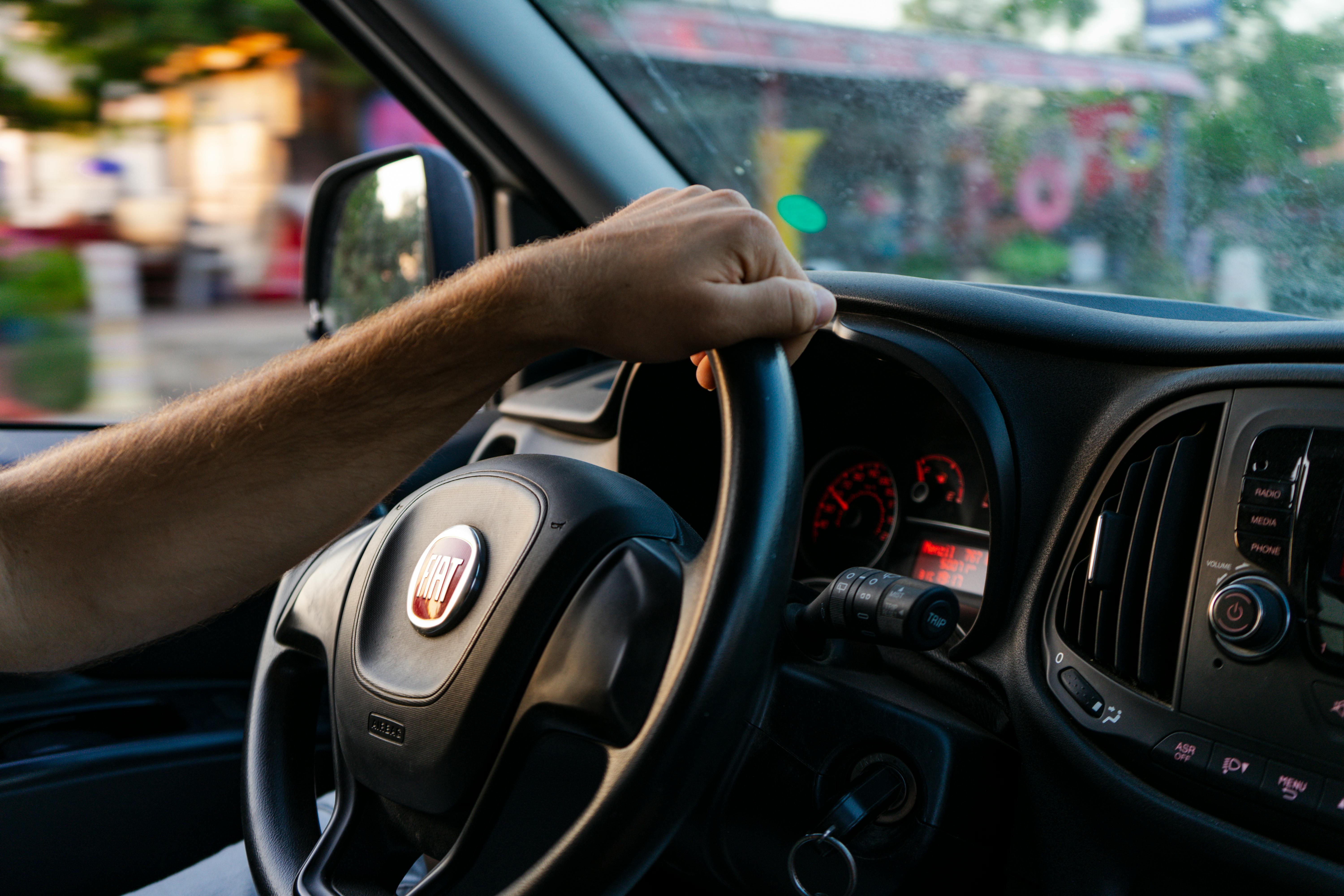 Close Up Photo of a Person Driving a Car · Free Stock Photo
