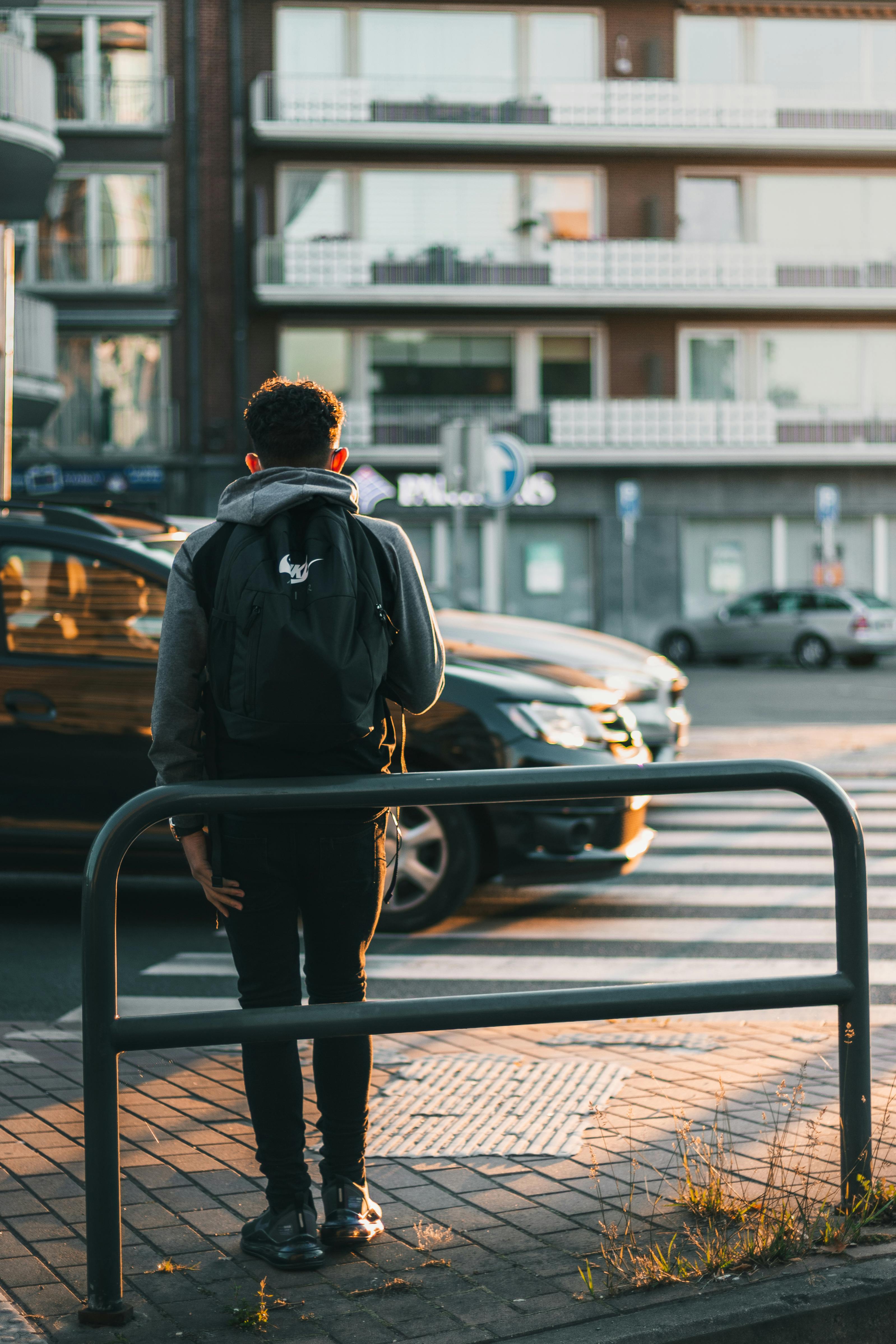 Young Man Waiting at Crosswalk · Free Stock Photo