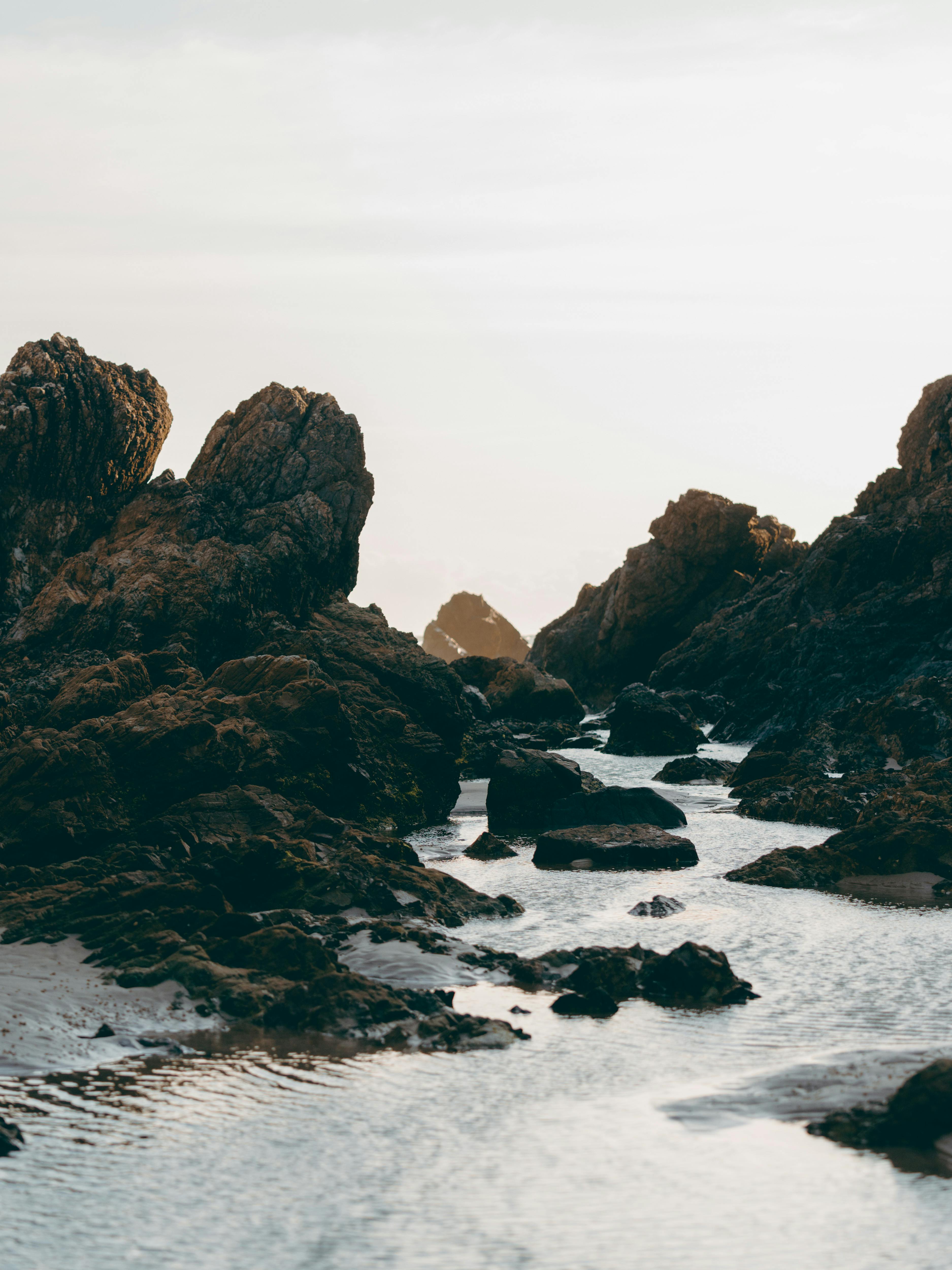 Rock Formation on Body of Water · Free Stock Photo