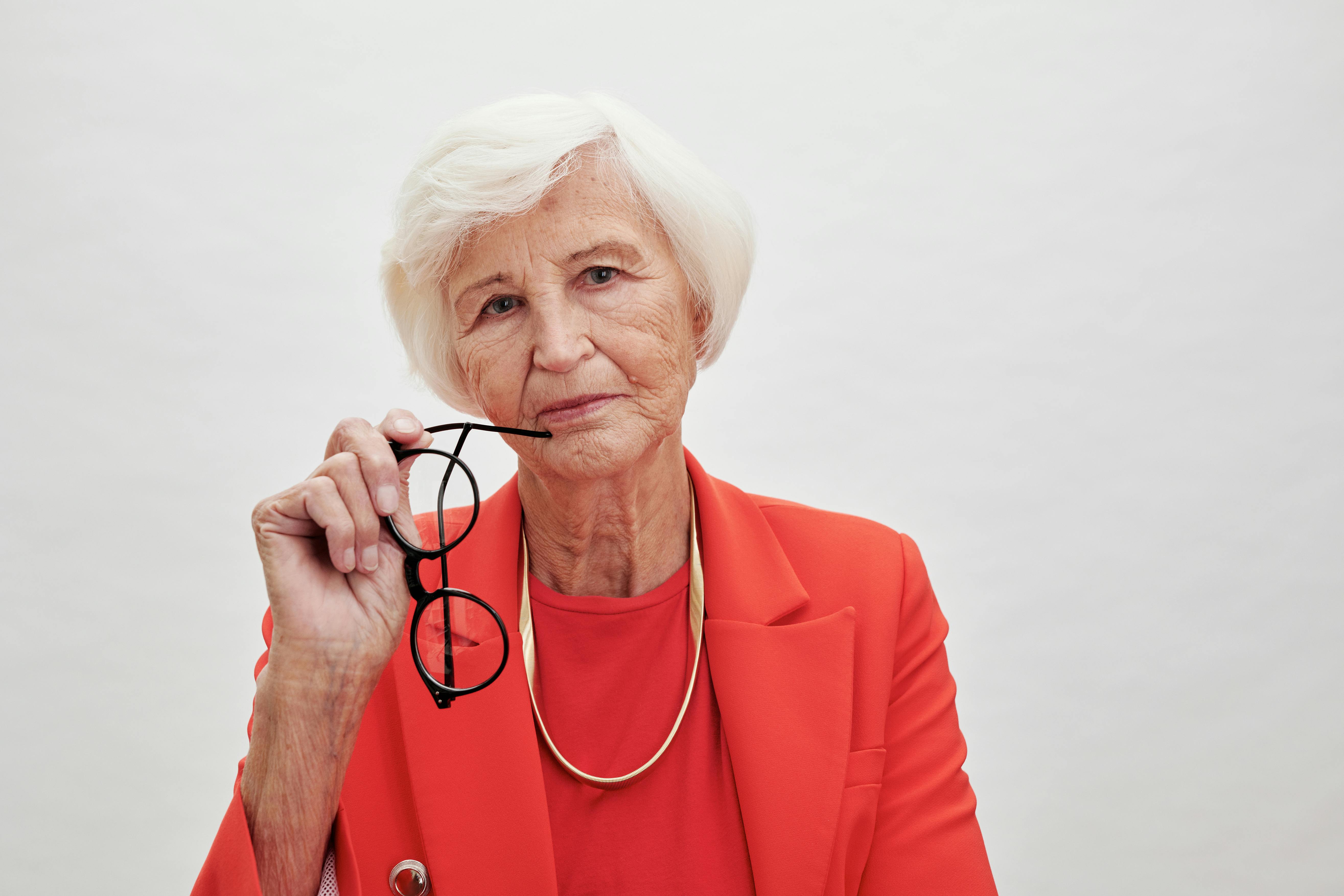 Elderly Woman Holding Eyeglasses · Free Stock Photo