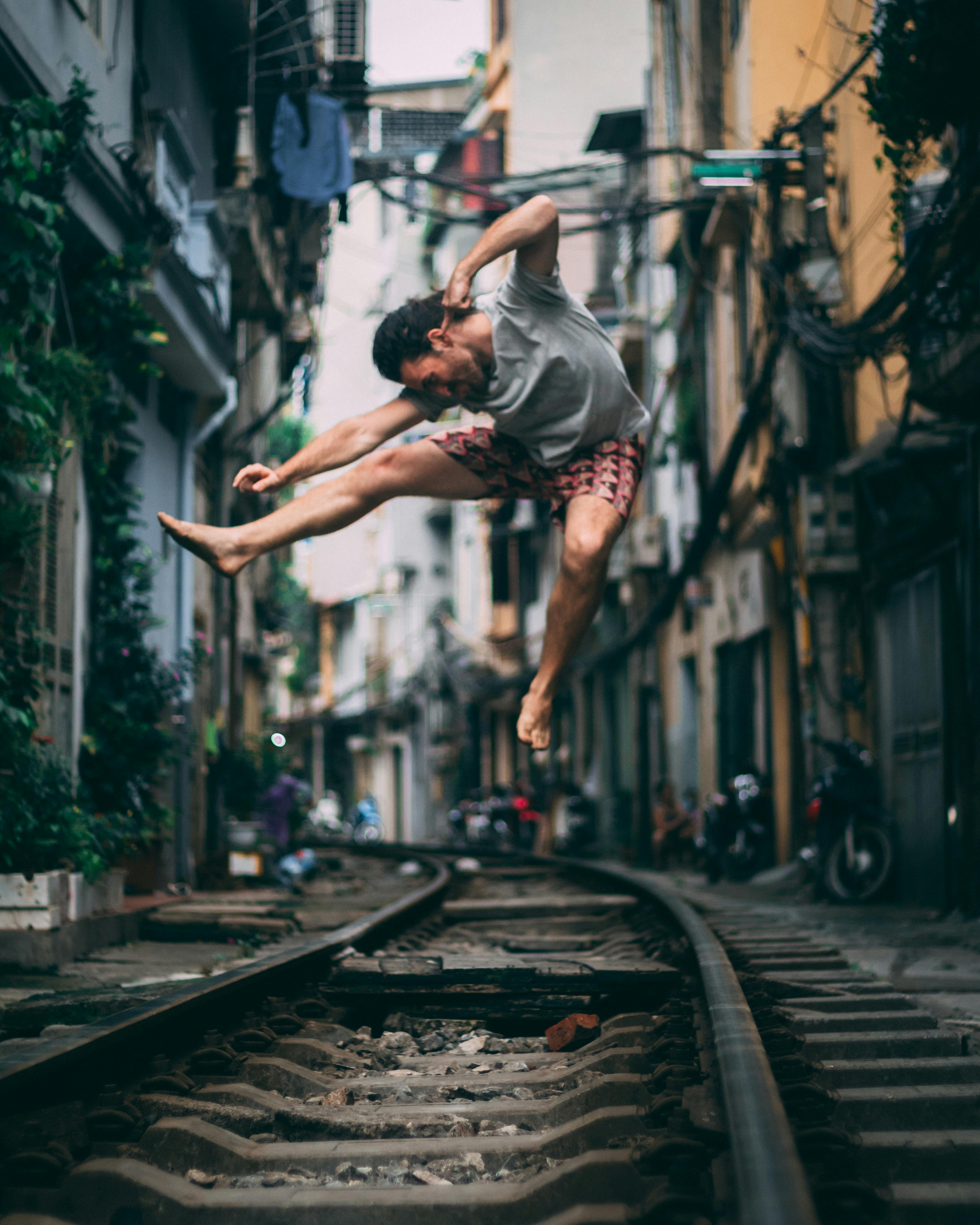 Man Jumping on Railway · Free Stock Photo