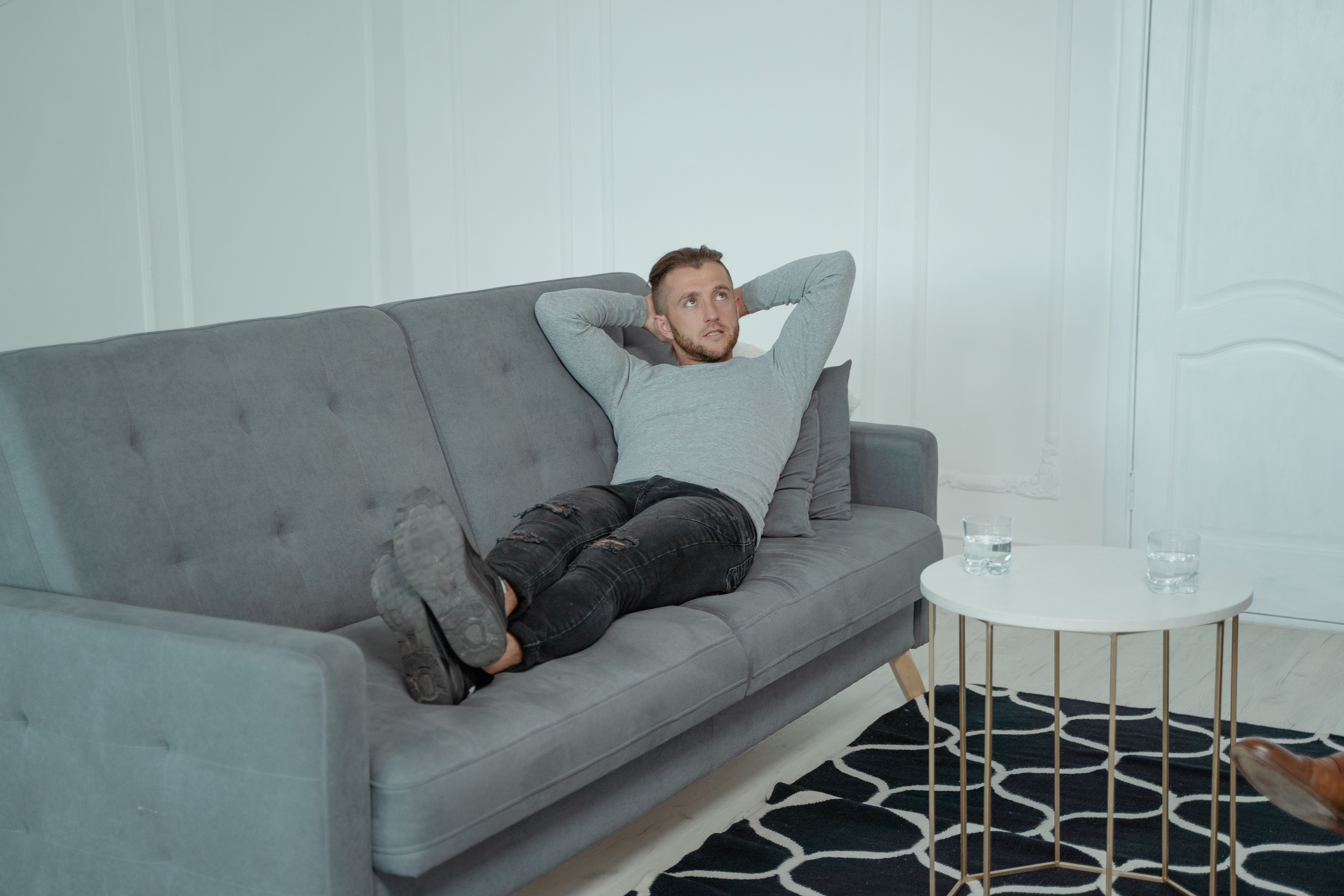 A Man Sitting on a Couch with his Legs up · Free Stock Photo