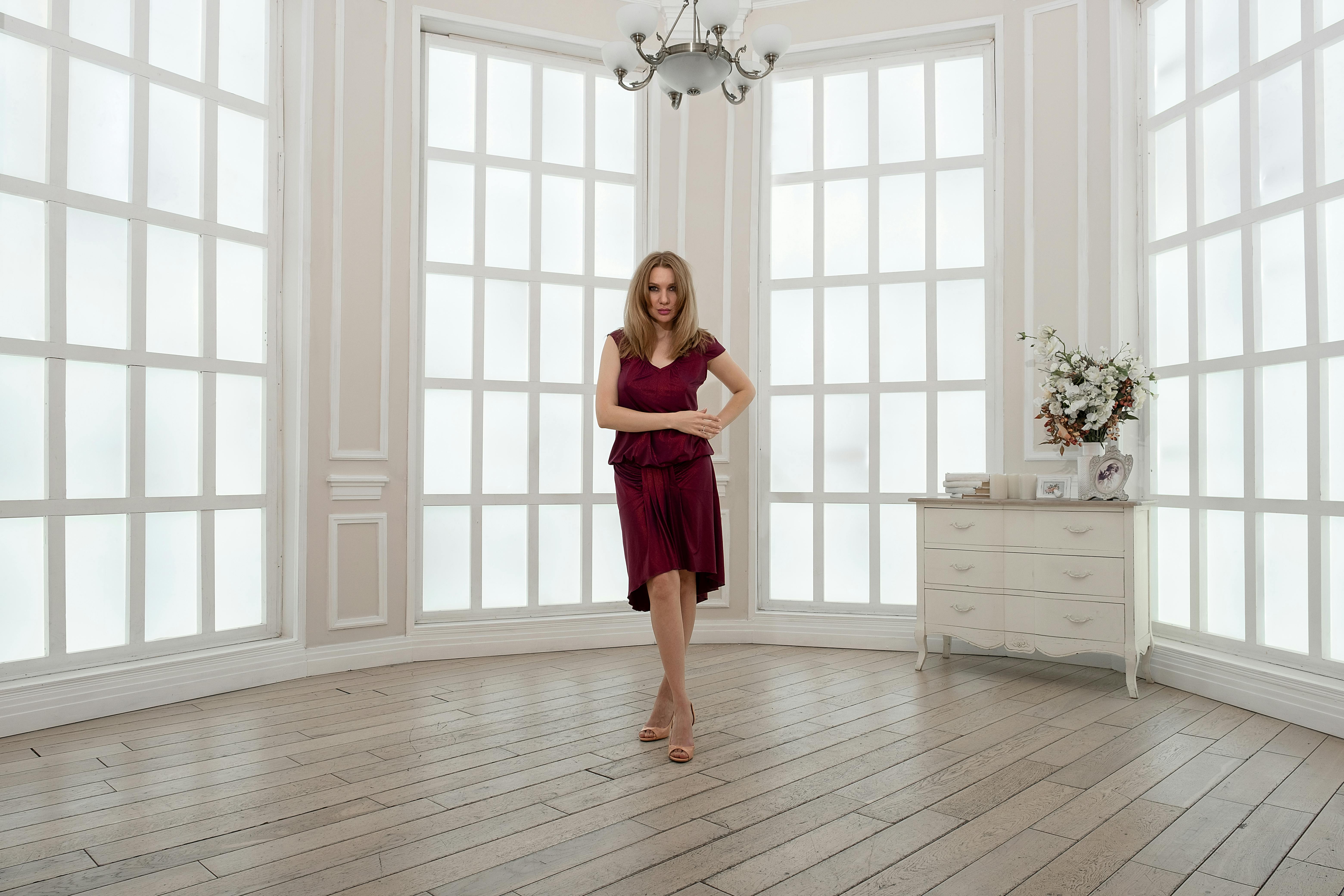 Graceful woman standing with hand on waist in light studio · Free Stock ...