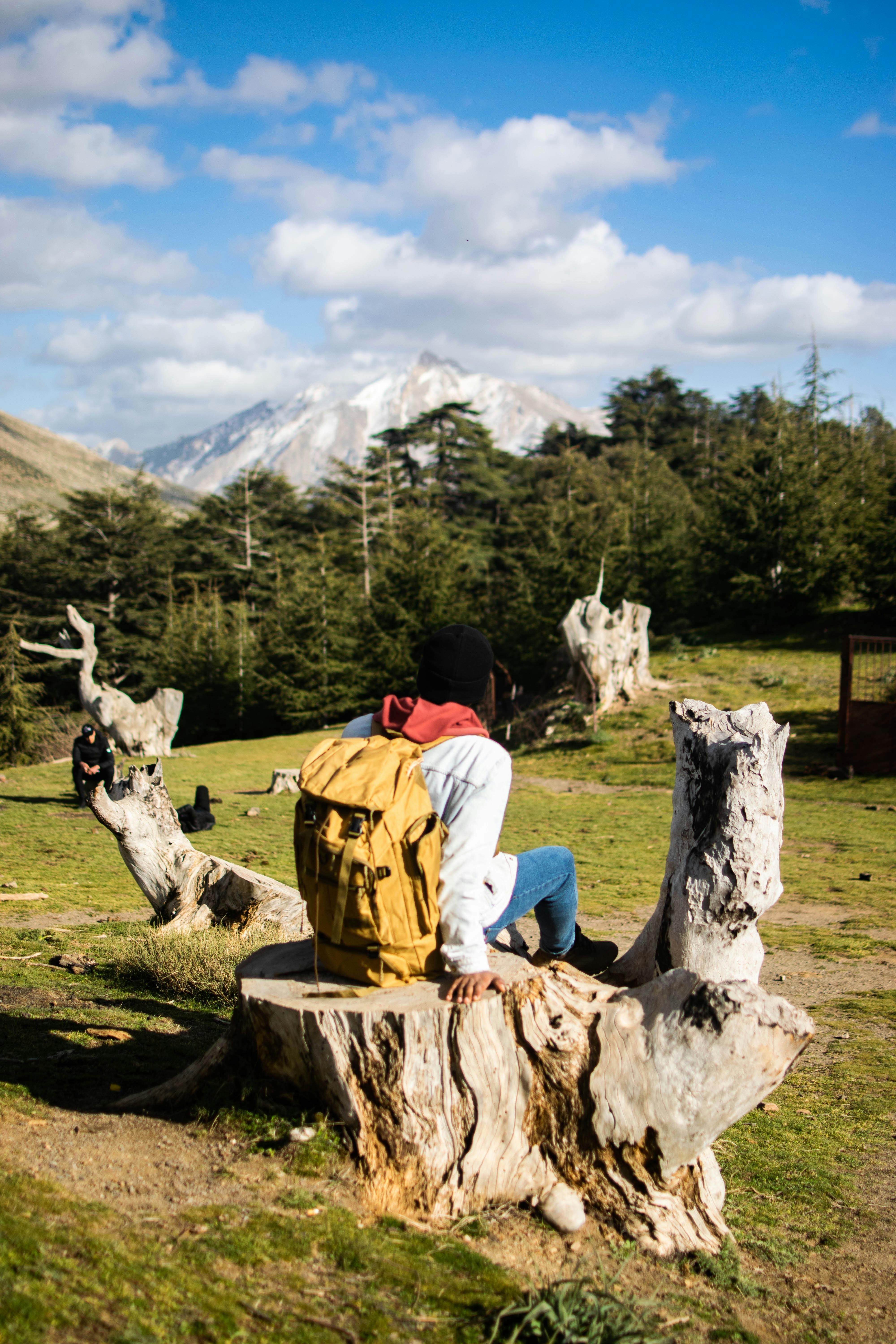 A Man Sitting Beside the Flagpole with Philippines Flag · Free Stock Photo