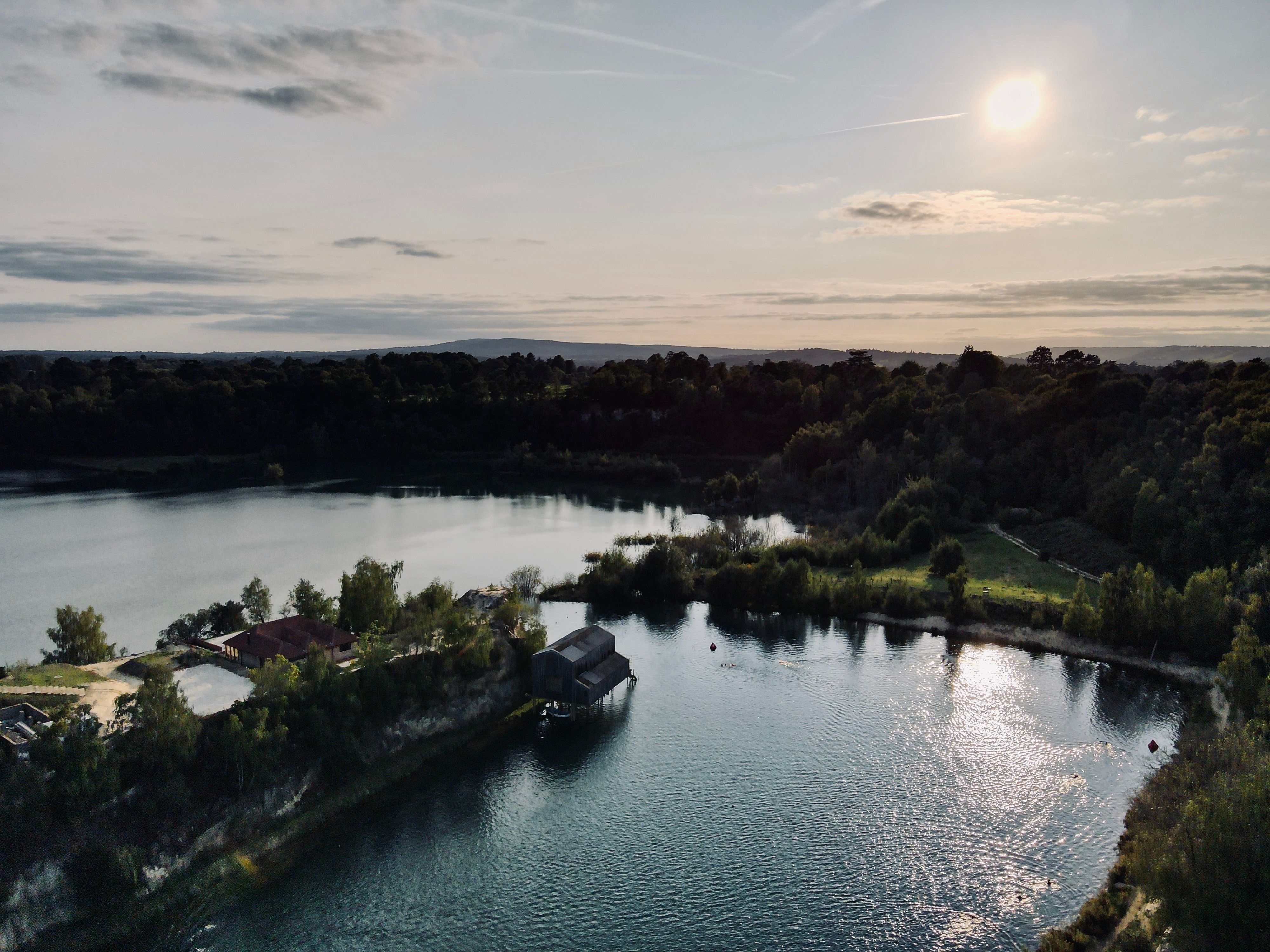 Fish farm with ponds under colorful sky at sunset · Free Stock Photo