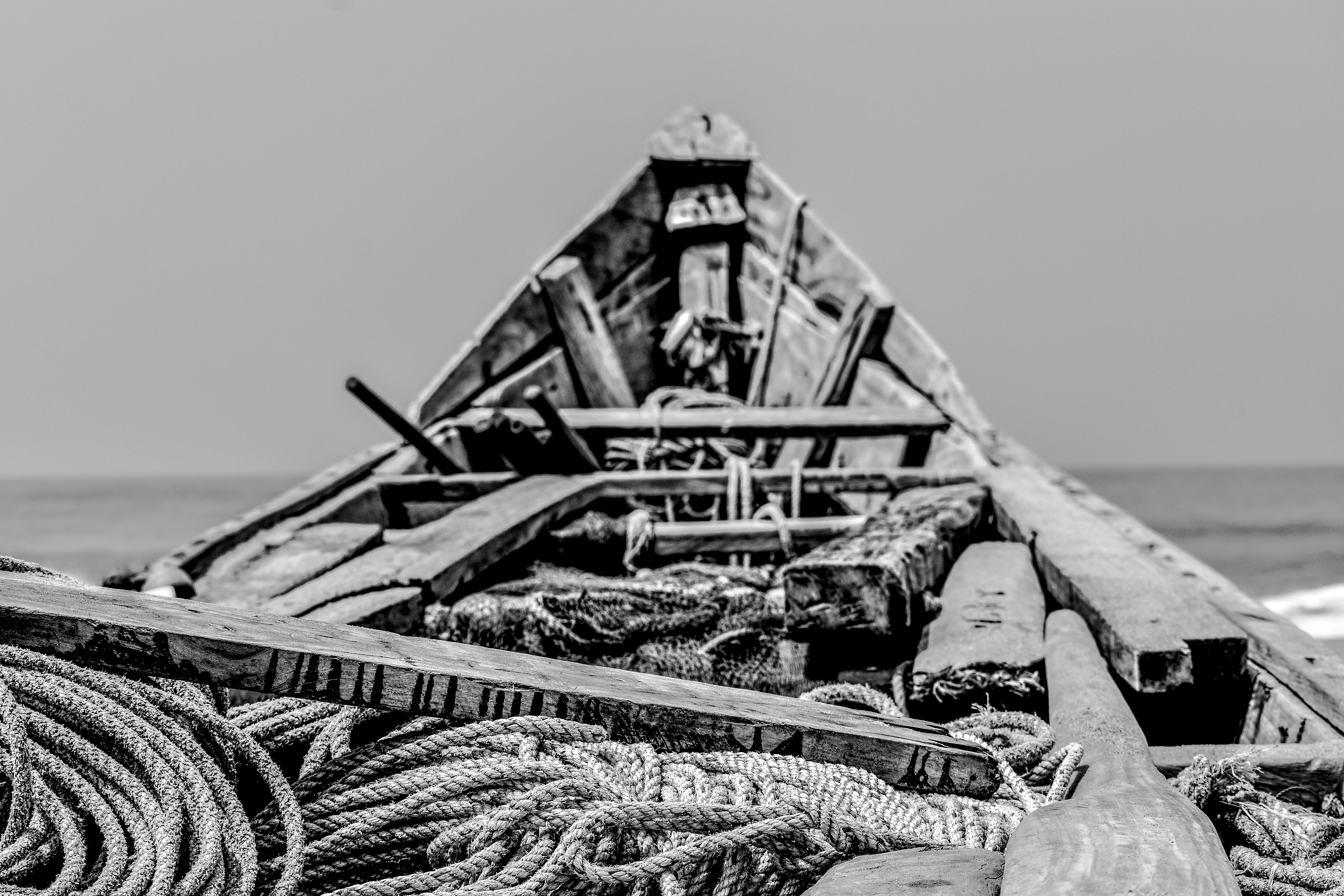A Man Rowing A Small Boat With a Sail · Free Stock Photo