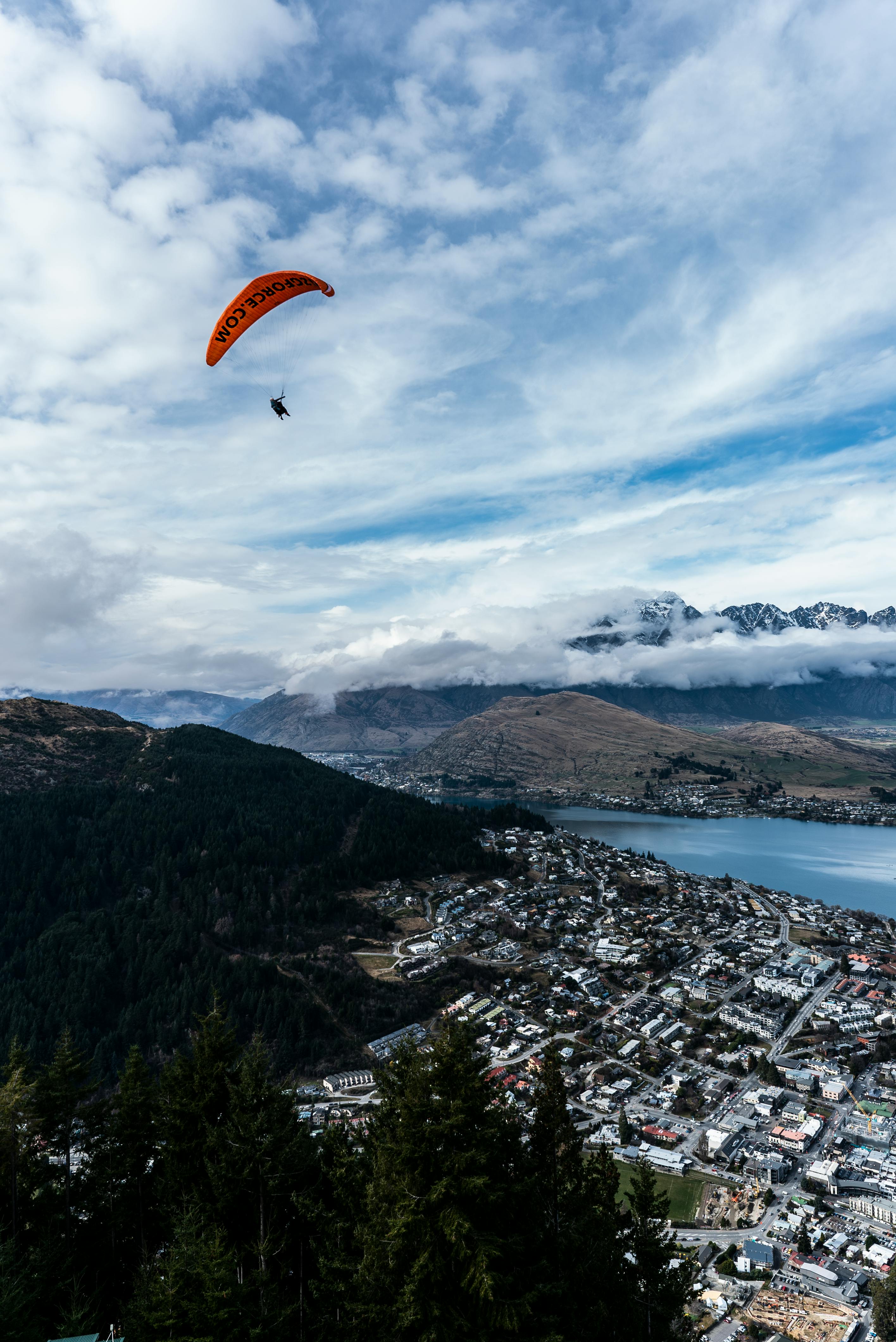 Silhouette of Man Flying on Parachute above Winter Mountains · Free ...