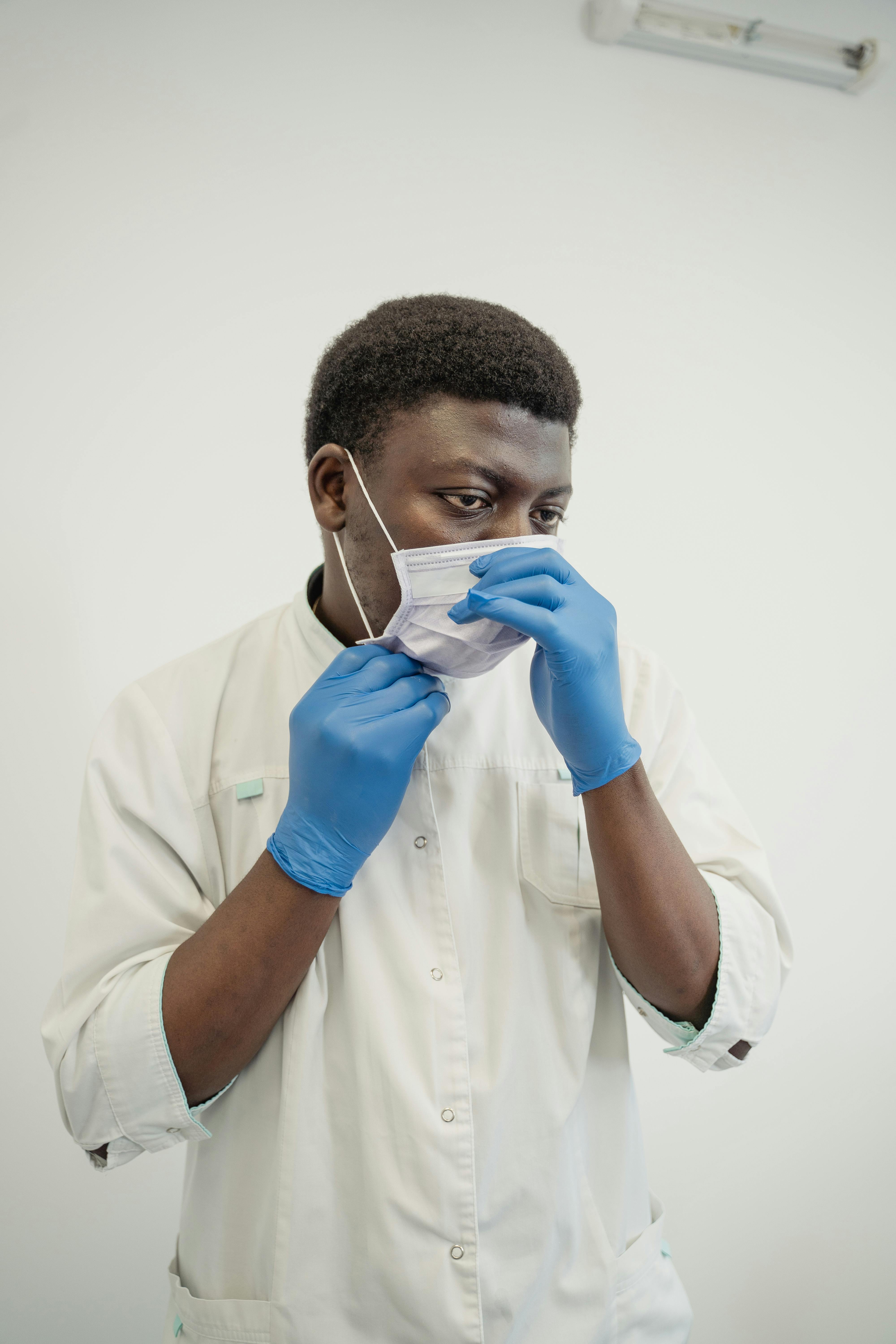 Medical Professional putting on a Face Mask · Free Stock Photo
