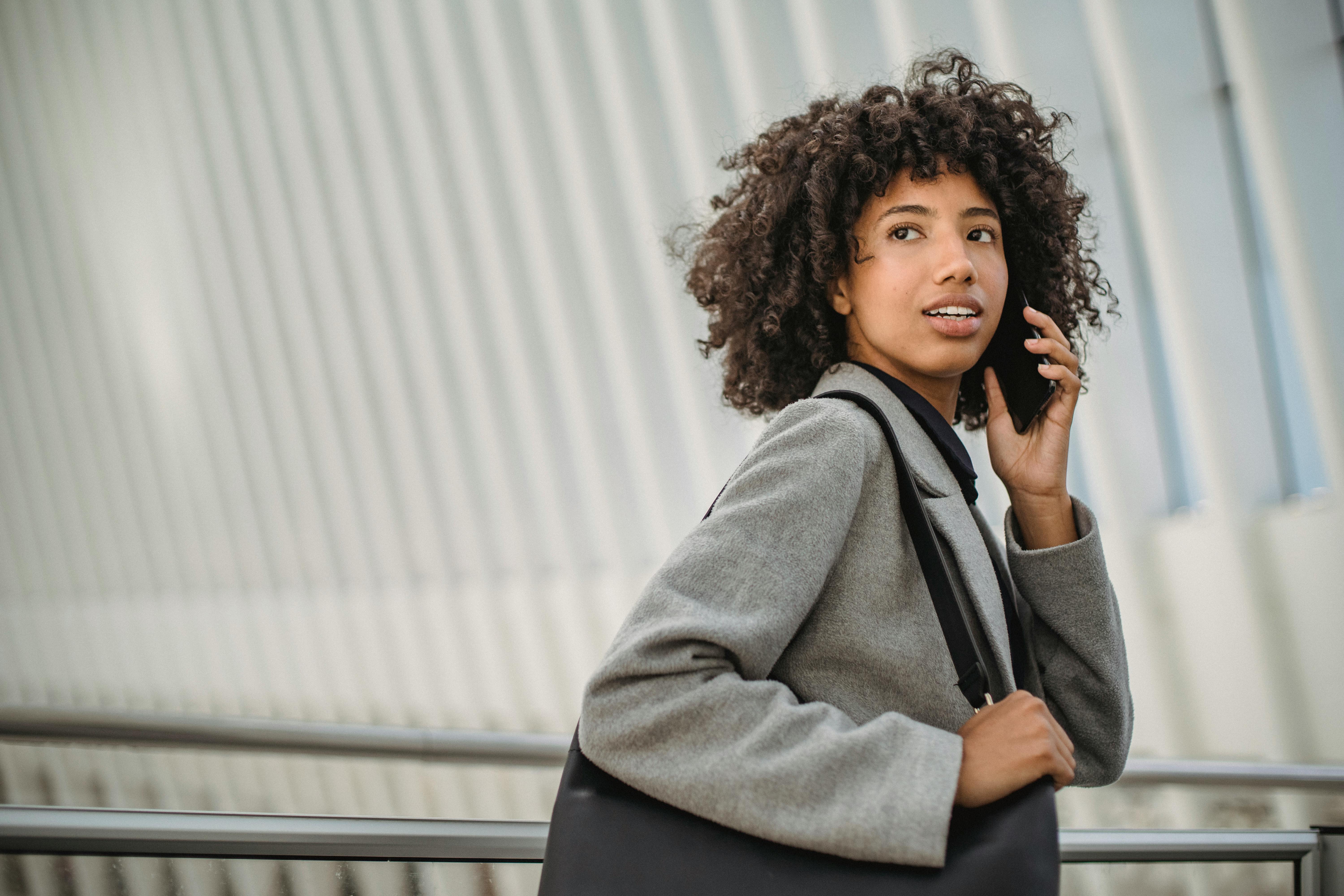 Black woman having phone call in mall · Free Stock Photo